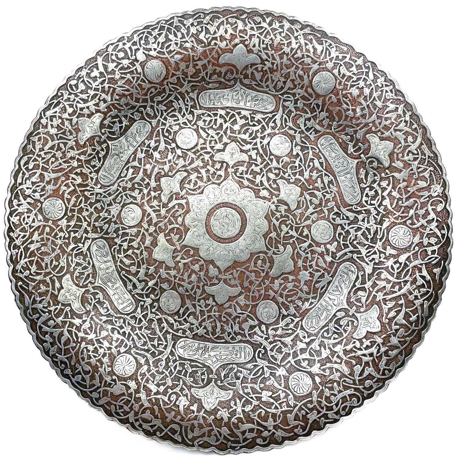 Lot 263 - A Persian copper and inlaid silver dish,