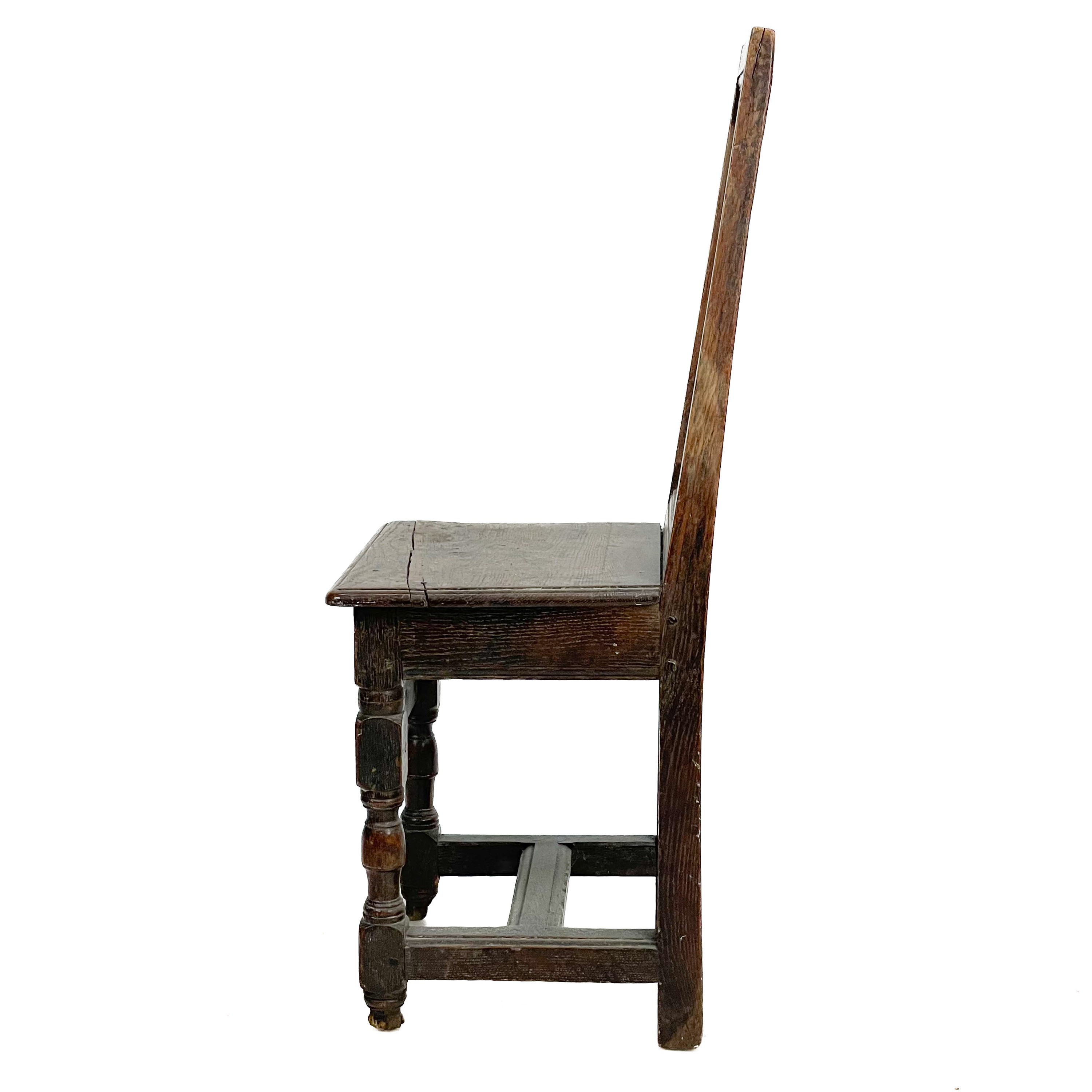 Lot 127 - A 17th century oak back stool.