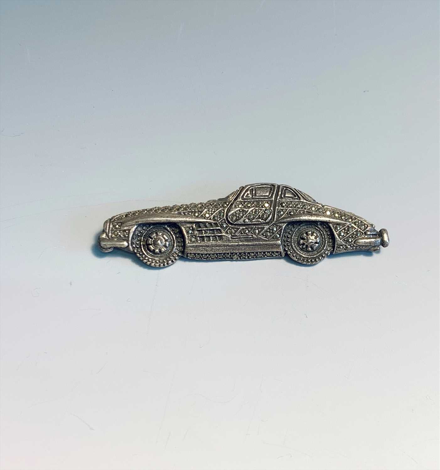 Lot 2540 - A stylish car brooch set with marcasite.