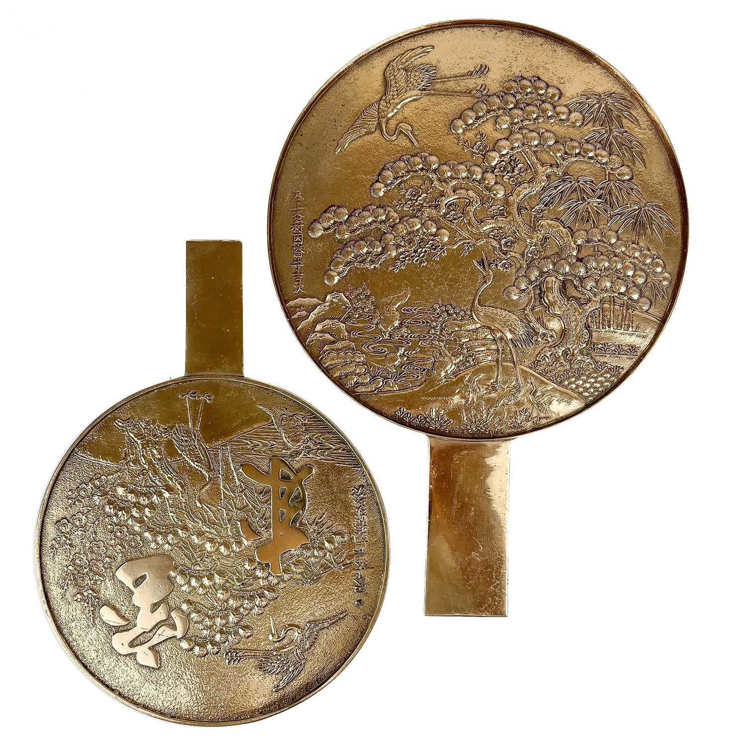 Lot 1439 - Two Japanese polished bronze mirrors.