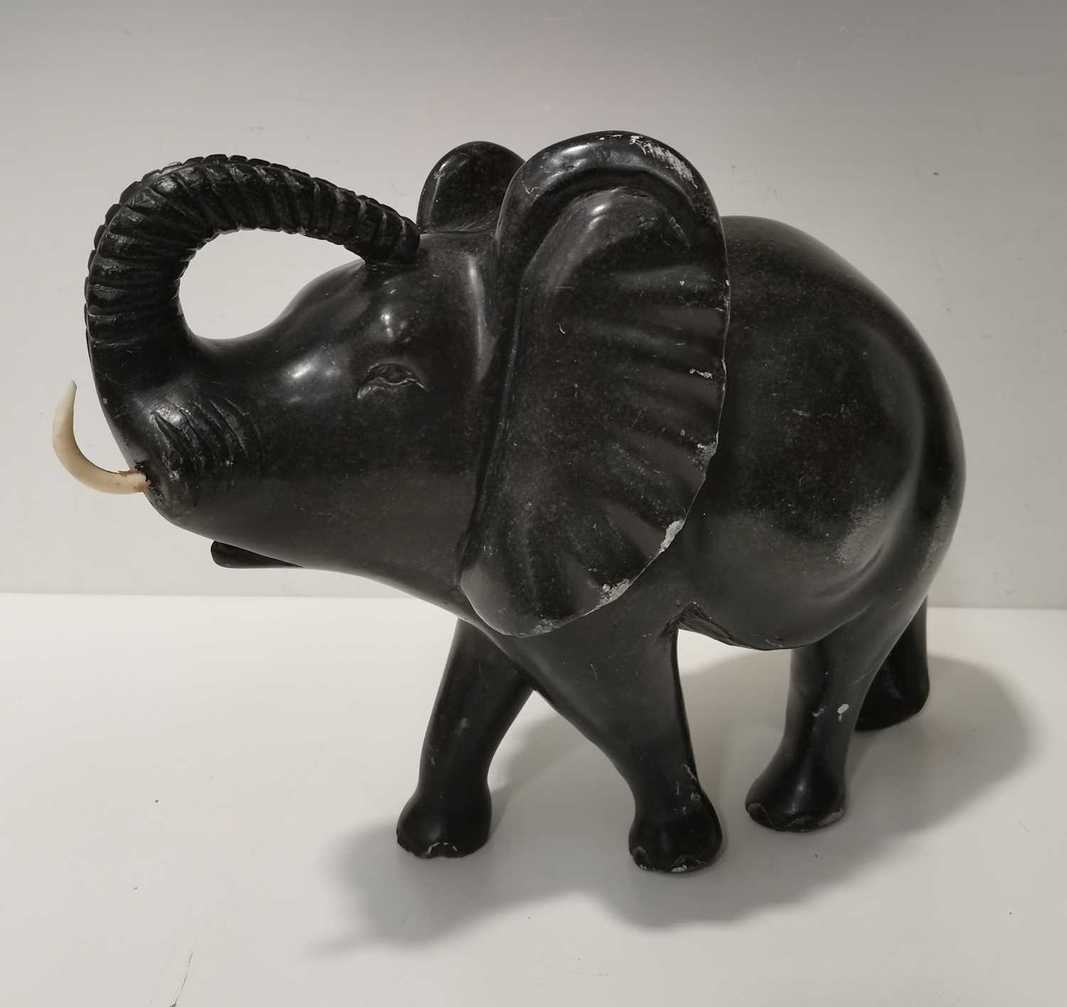 Lot 10 - A large heavy stone-carved elephant, 34cm in