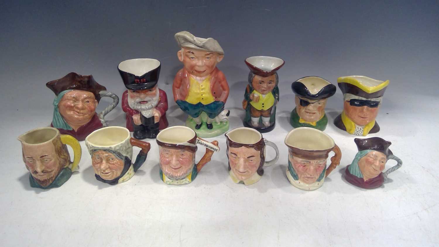 Lot 180 - A Collection of Small Toby Jugs. Twelve in