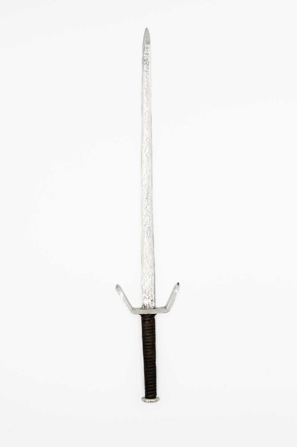 Lot 124 - A contemporary .999 fine silver sword paper
