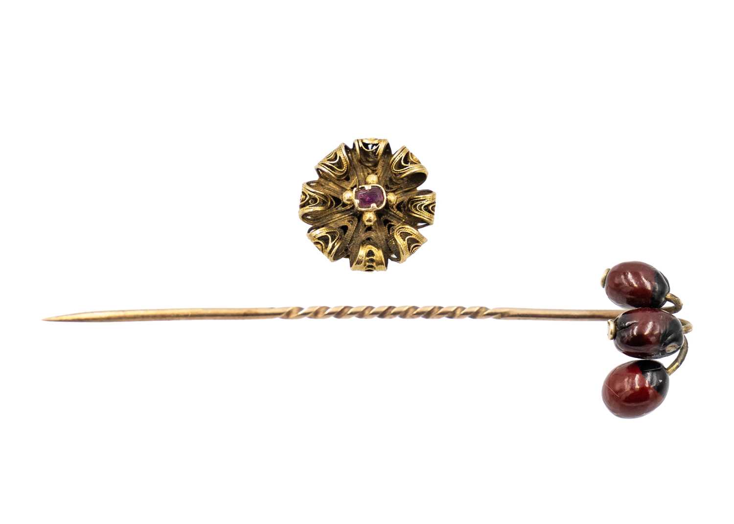 Lot 149 - A gold stick pin with three painted amber