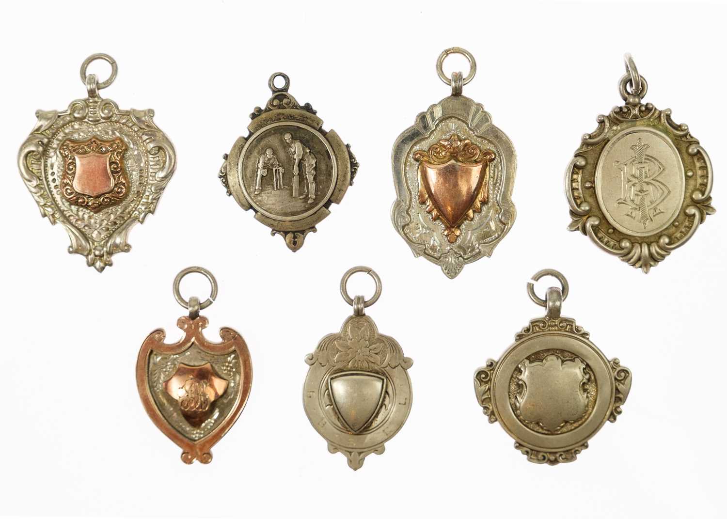 Lot 97 - A collection of seven silver shield fobs.