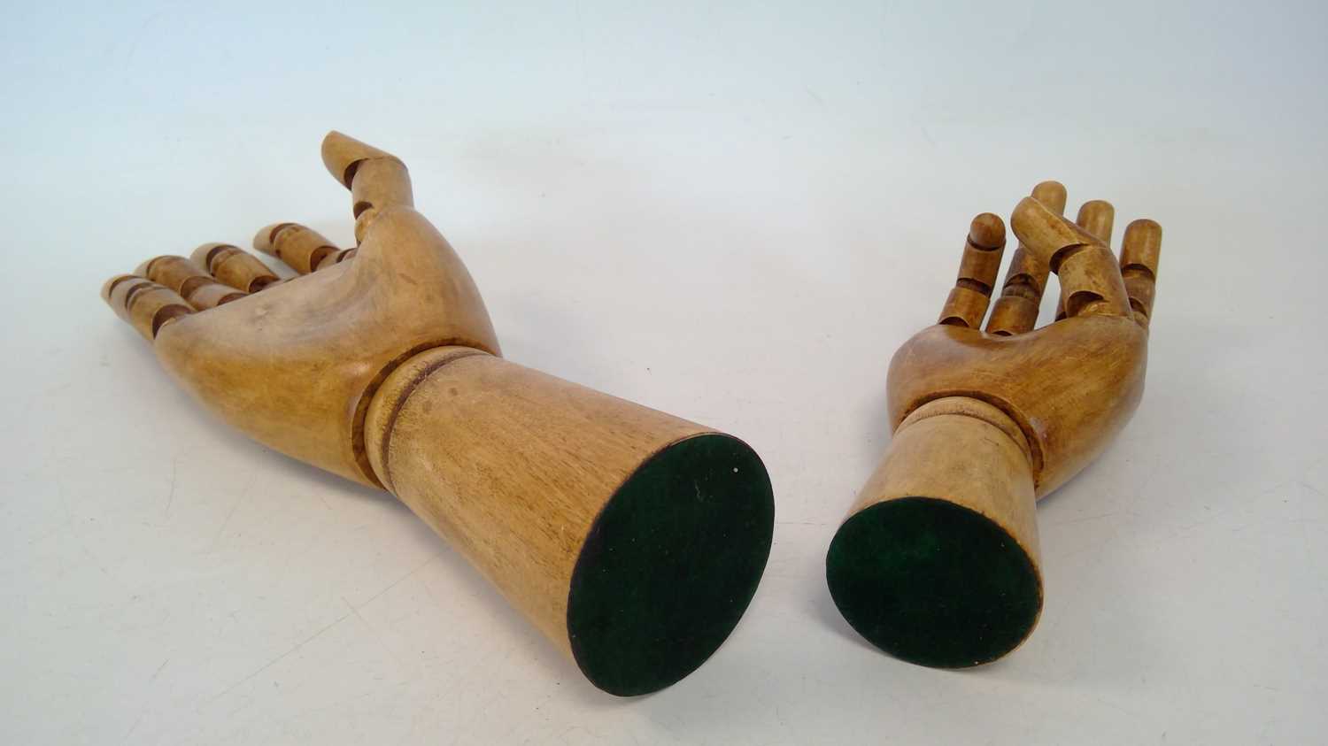 Lot 105 - Two articulated wooden hand mannequins, the
