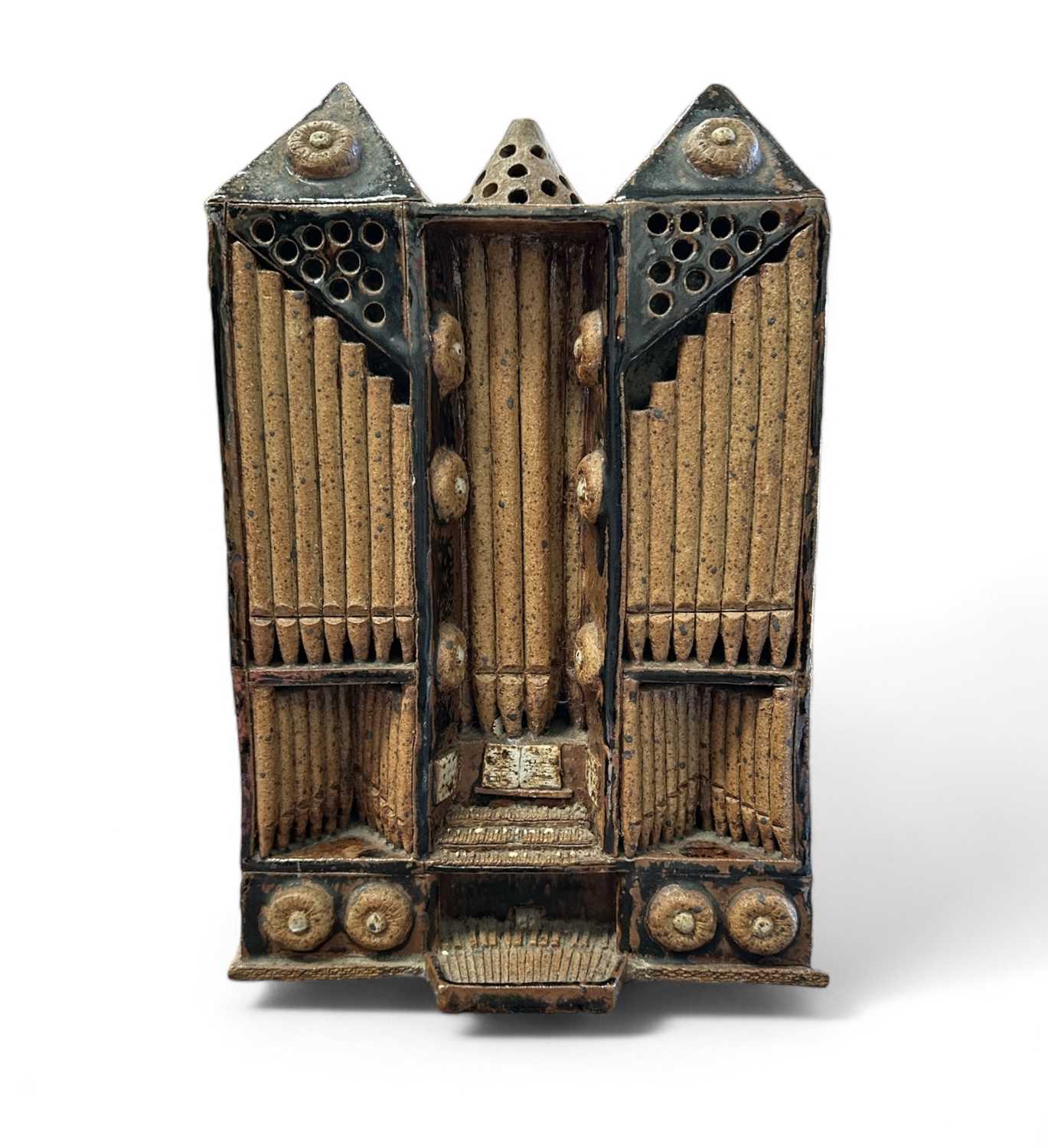 Lot 119 - A pottery church organ, 30cm in height.