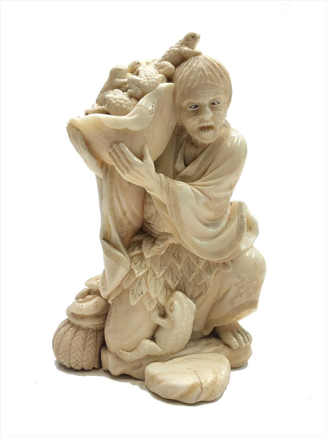 Lot 172 - A Japanese ivory okimono of a toad catcher,