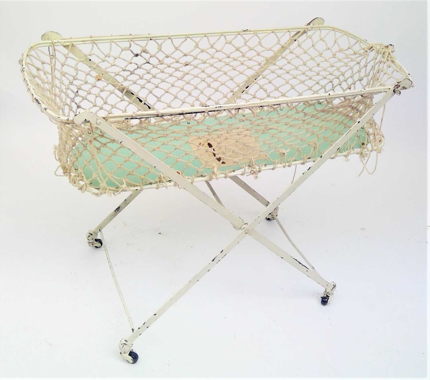 Lot 3541 - A folding wrought iron framed cot.