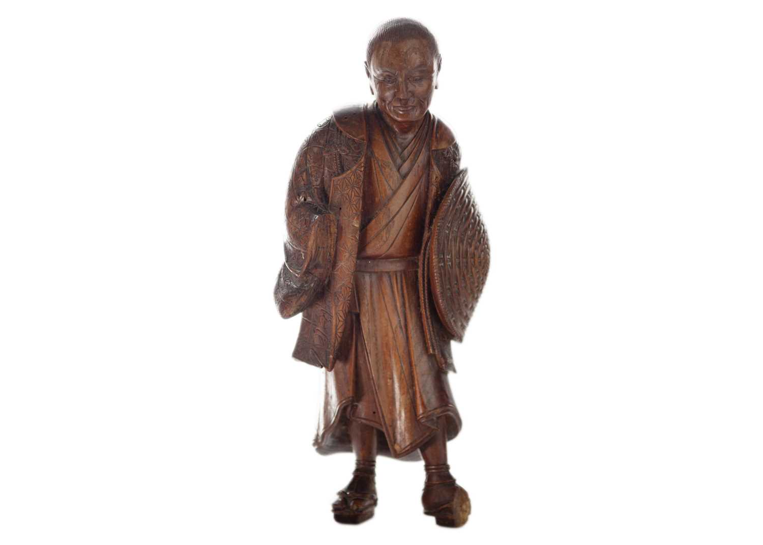 Lot 693 - A Japanese elm figure of an elderly gent.