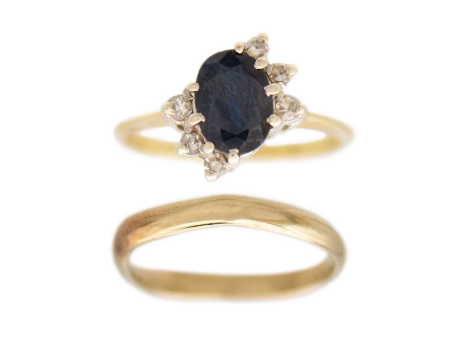 Lot 139 - An 18k gold dark blue sapphire and diamonds