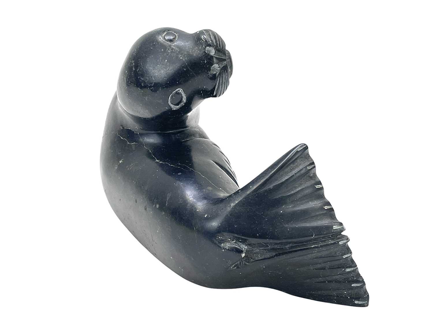 Lot 104 - An Inuit Eskimo carved soapstone grey seal.