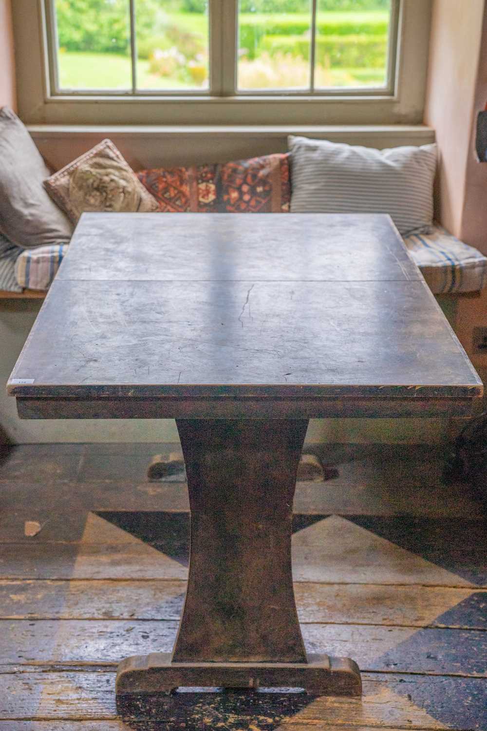 Lot 116 - A stained beech extending dining table.