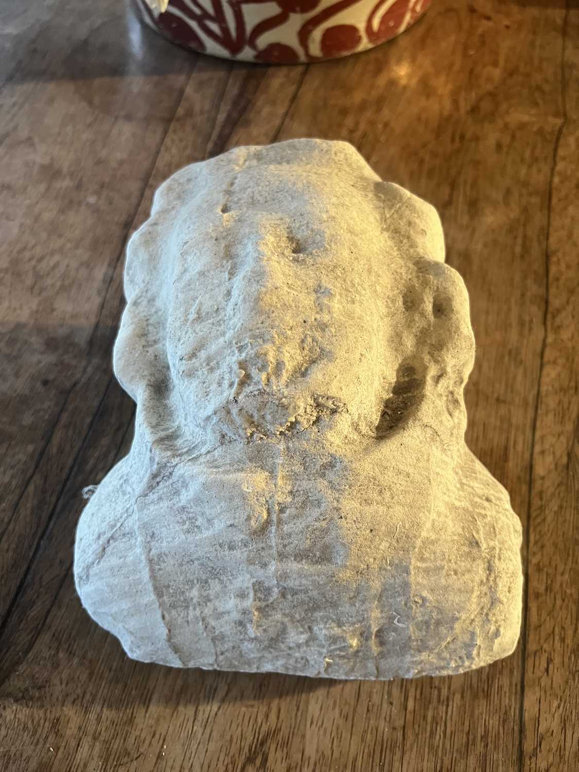 Lot 425 - An ancient weathered stone corbel head