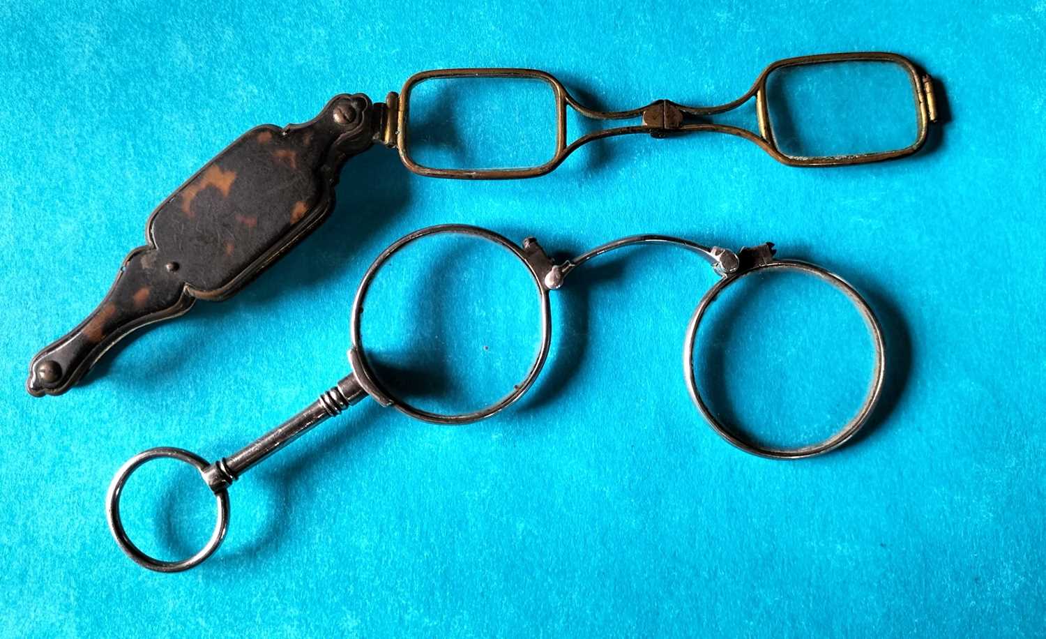 Lot 140 - A pair of white metal lorgnettes.