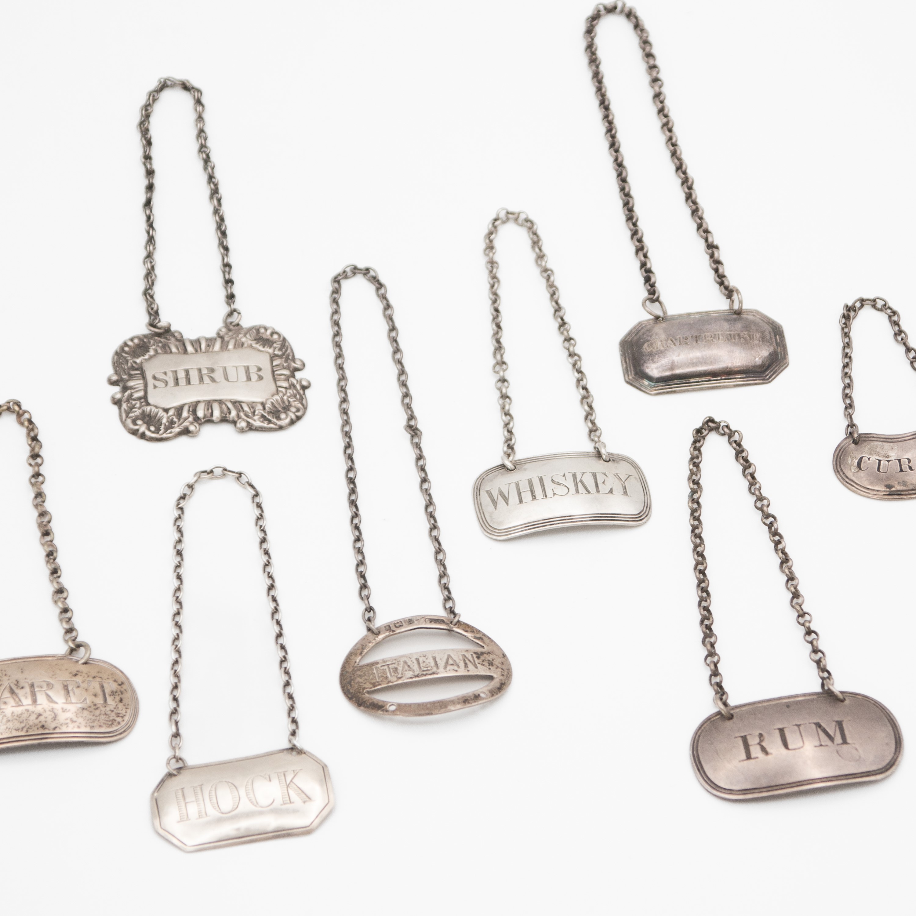 Lot 145 - A selection of eight silver wine labels.