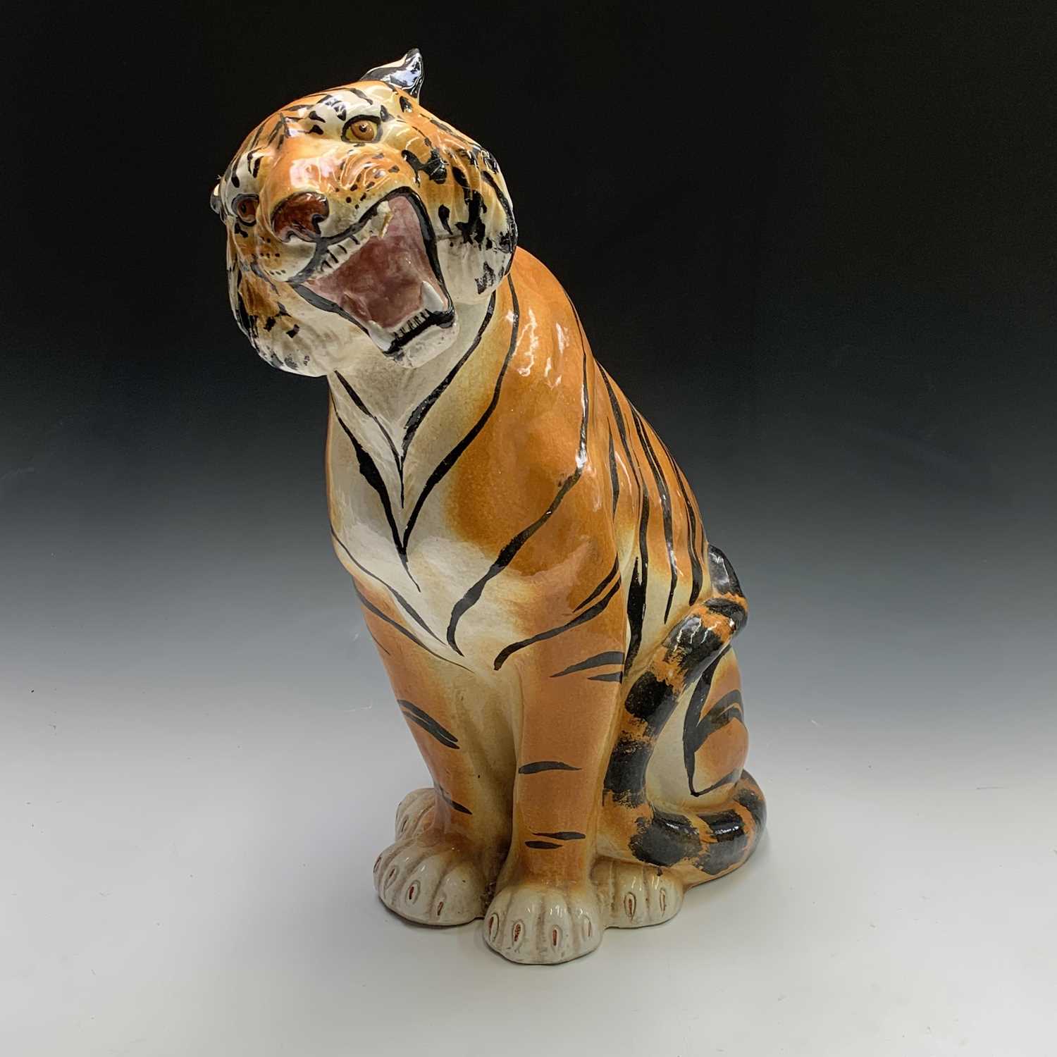 Lot 926 - A large ceramic model of a seated tiger.