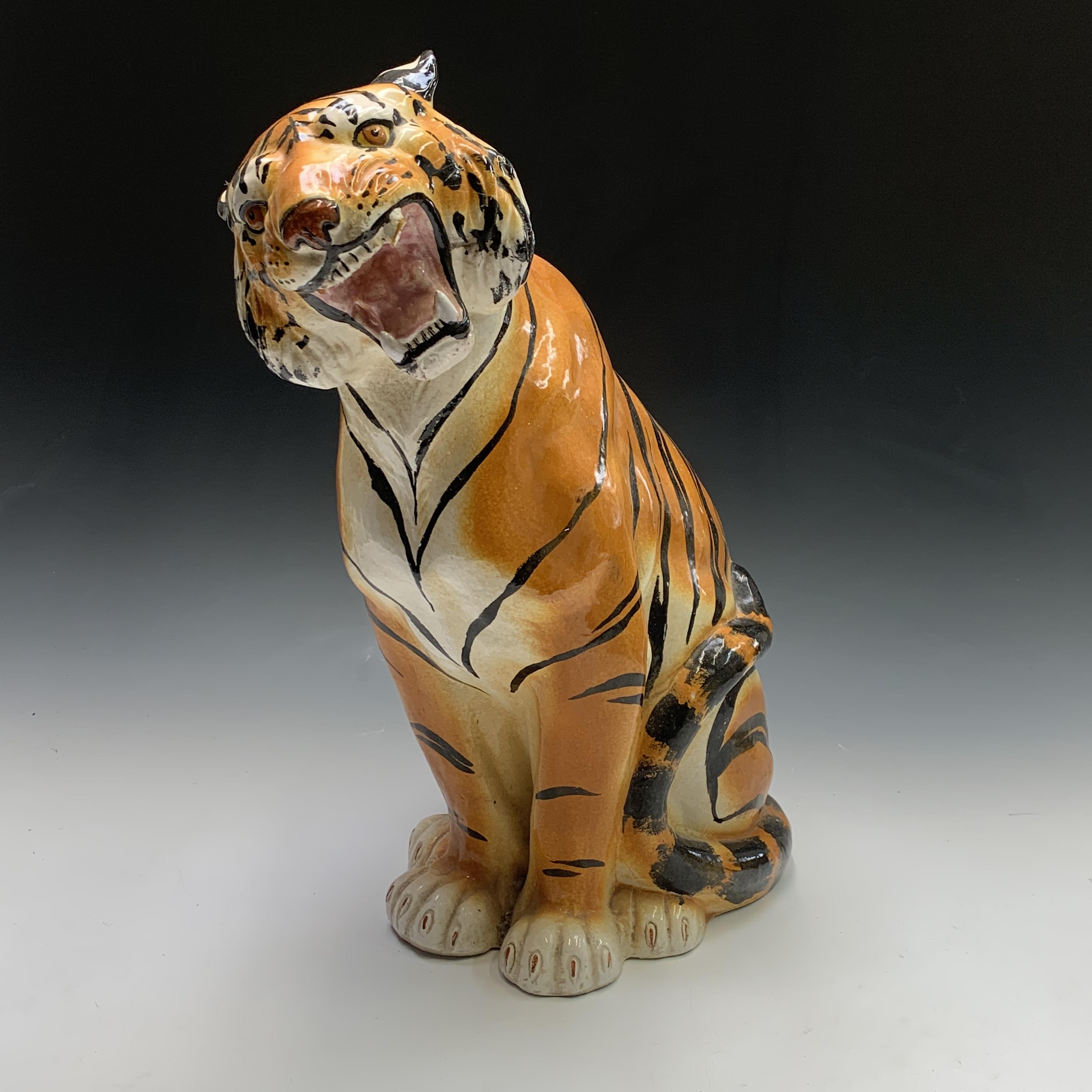 Lot 926 - A large ceramic model of a seated tiger.
