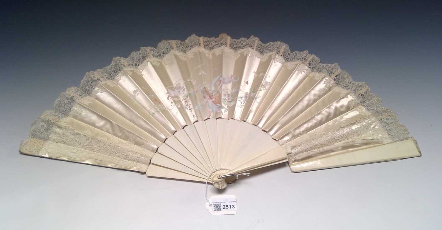 Lot 2513 - A fan the panel painted with putti and