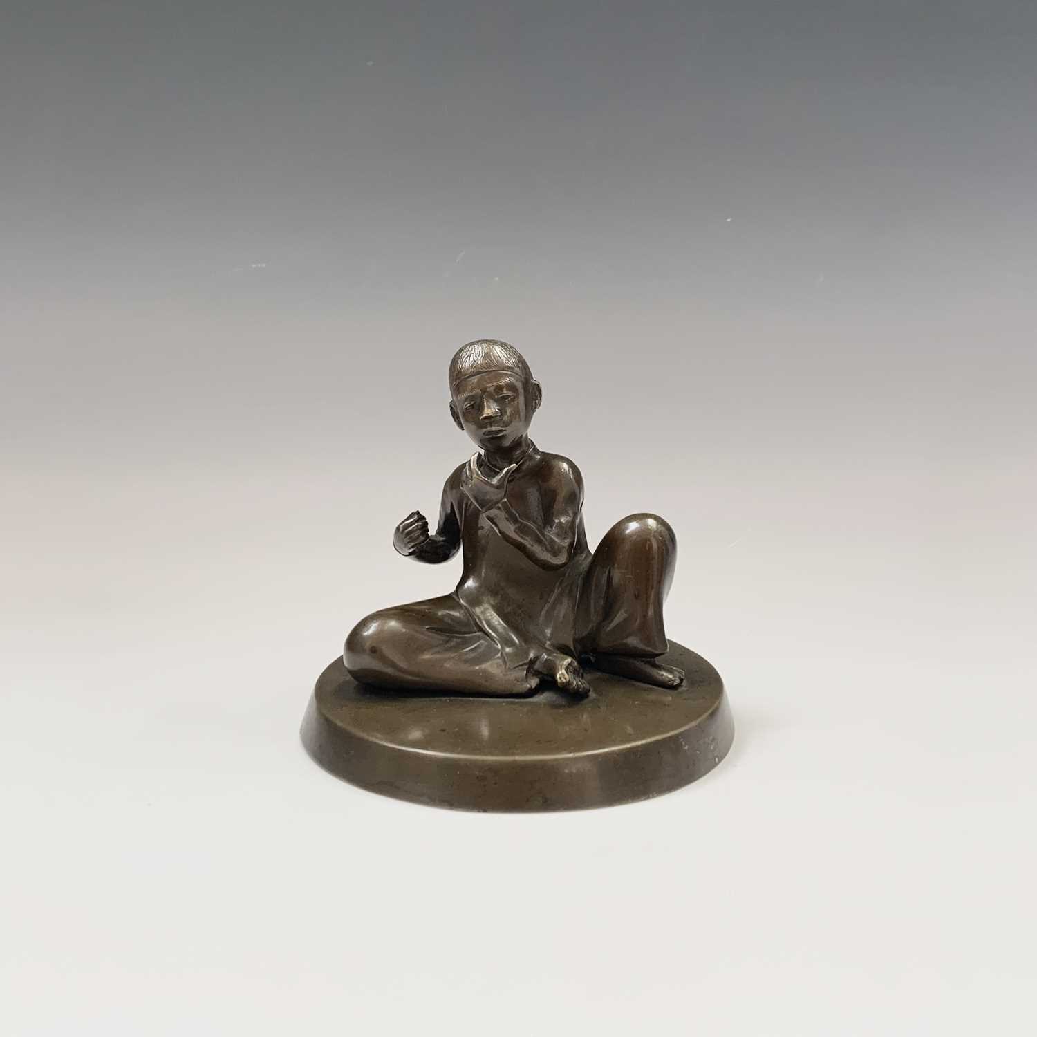 Lot 161 - A Japanese bronze figure of a seated boy,
