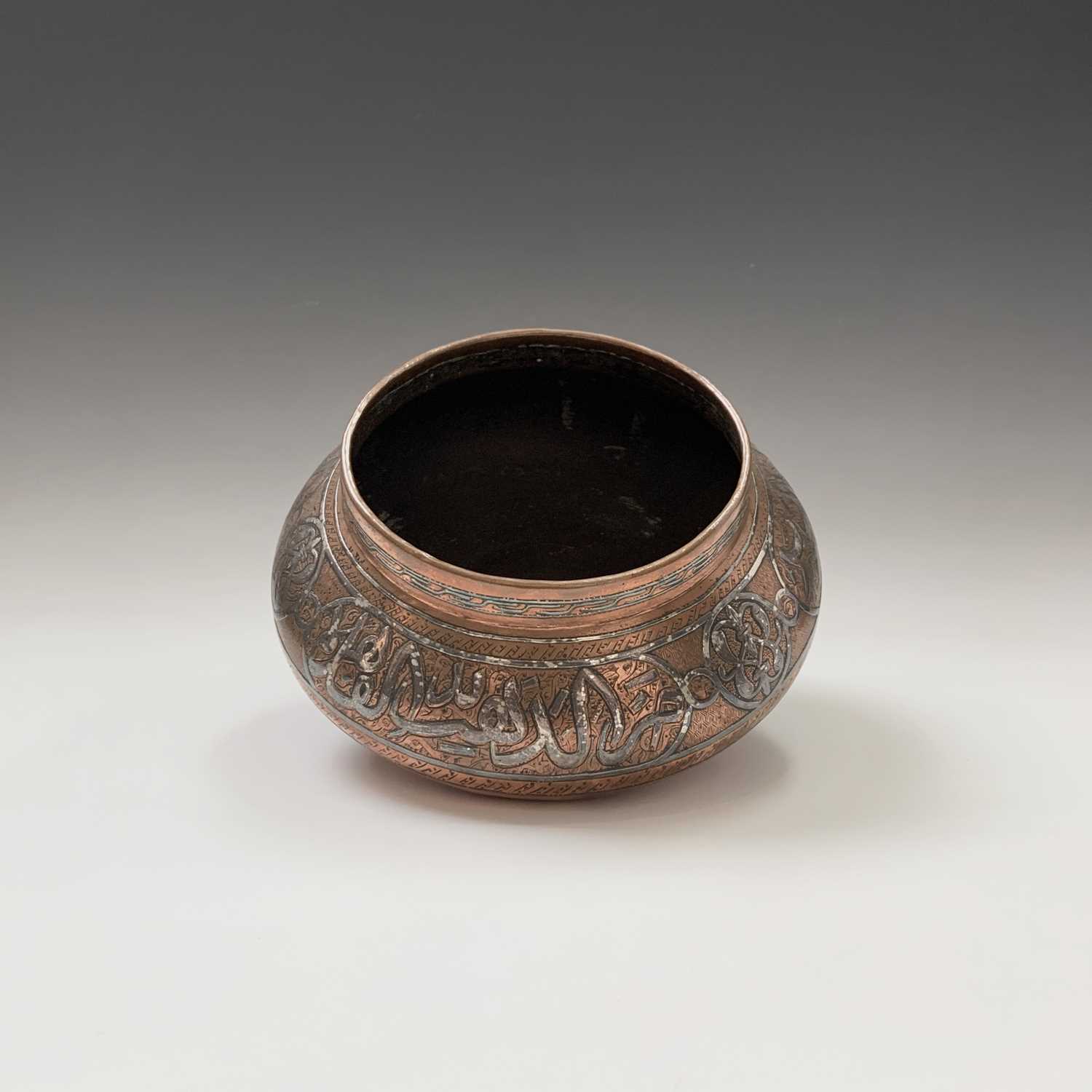Lot 363 - A Cairoware copper and silver inlaid bowl,