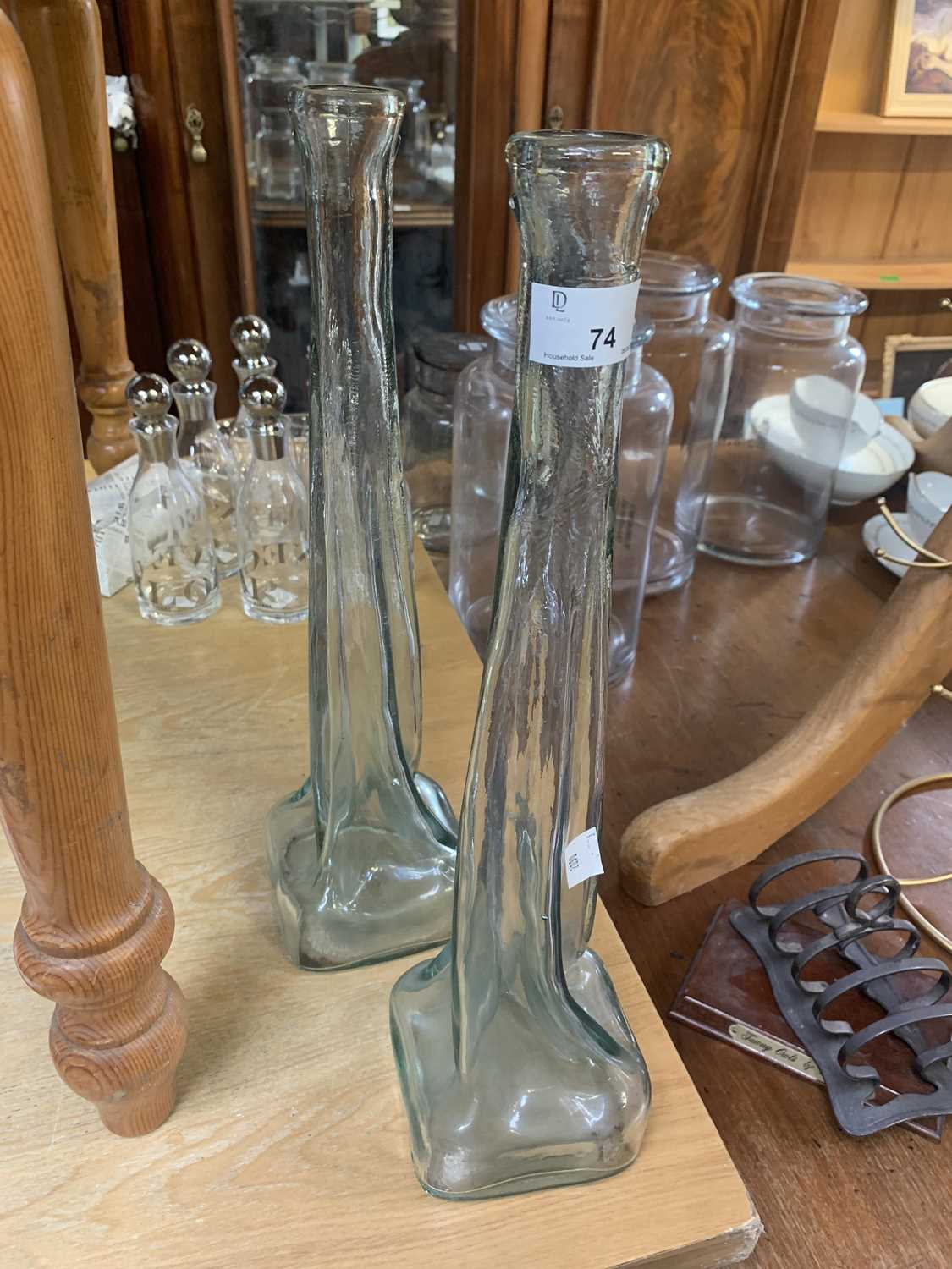 Lot 74 - Two unusual twisted glass bottle vases.