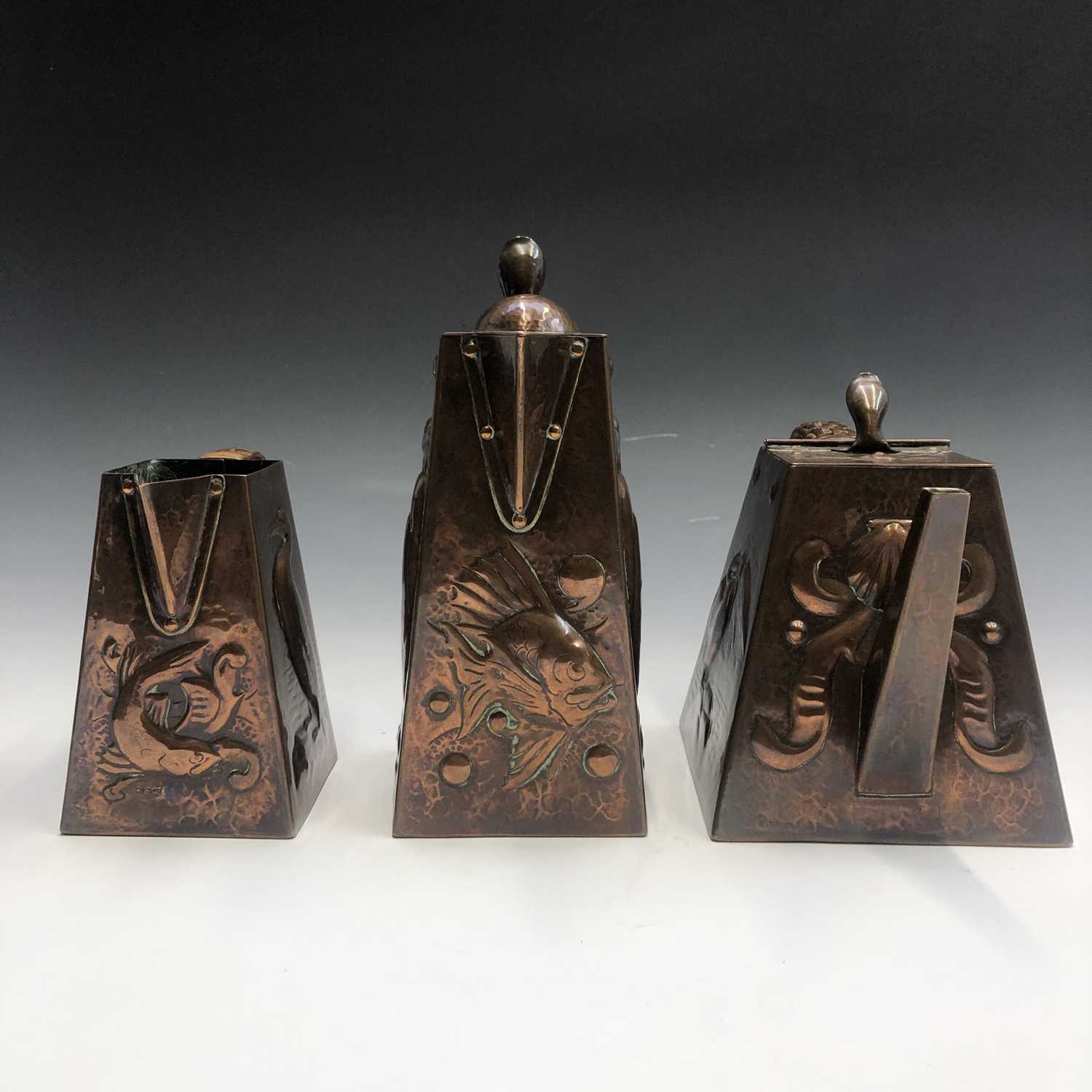 Lot 190 - A Newlyn copper three piece tea set