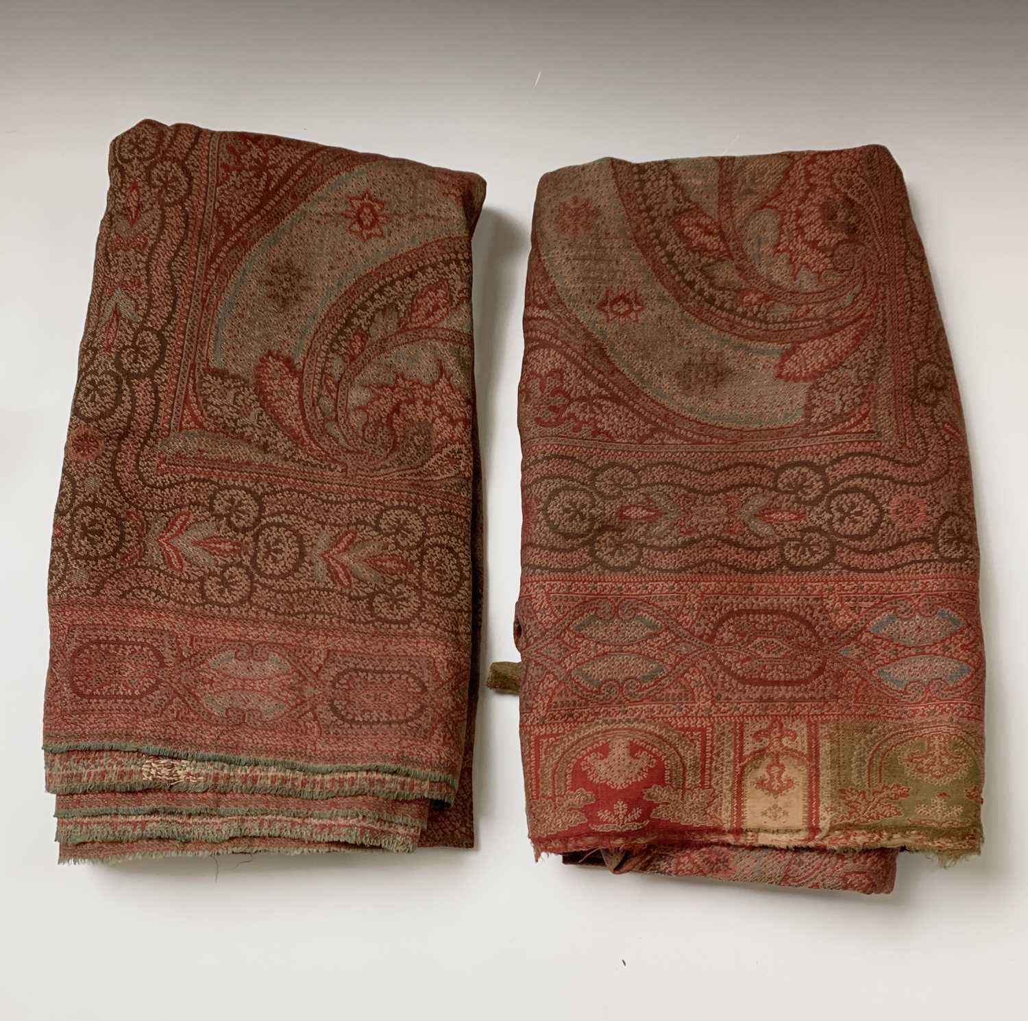 Lot 1057 - A woven paisley shawl, in two pieces, 140 x