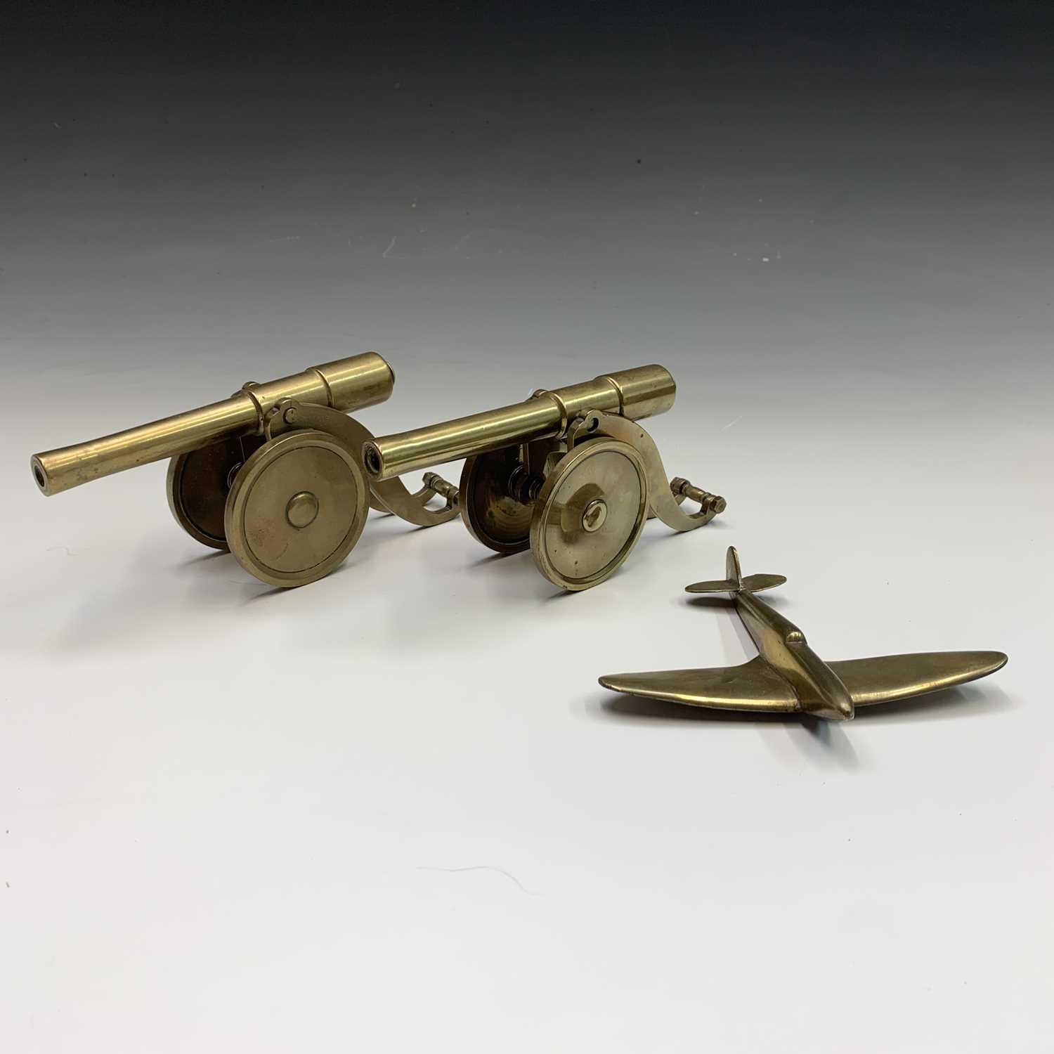 Lot 597 - A pair of model brass cannon, length 20cm,