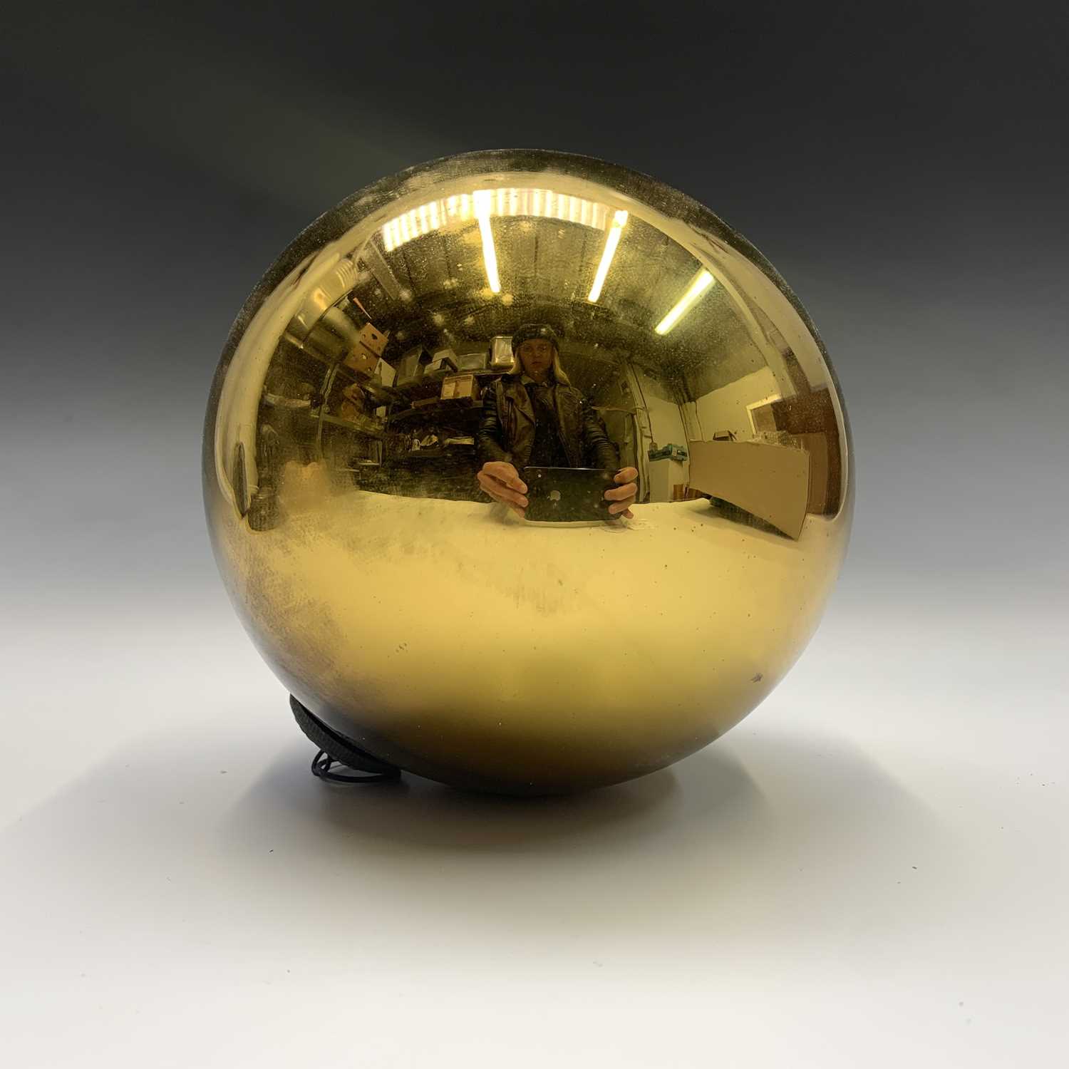 Lot 643 - A gold mirrored glass witch ball. Diameter