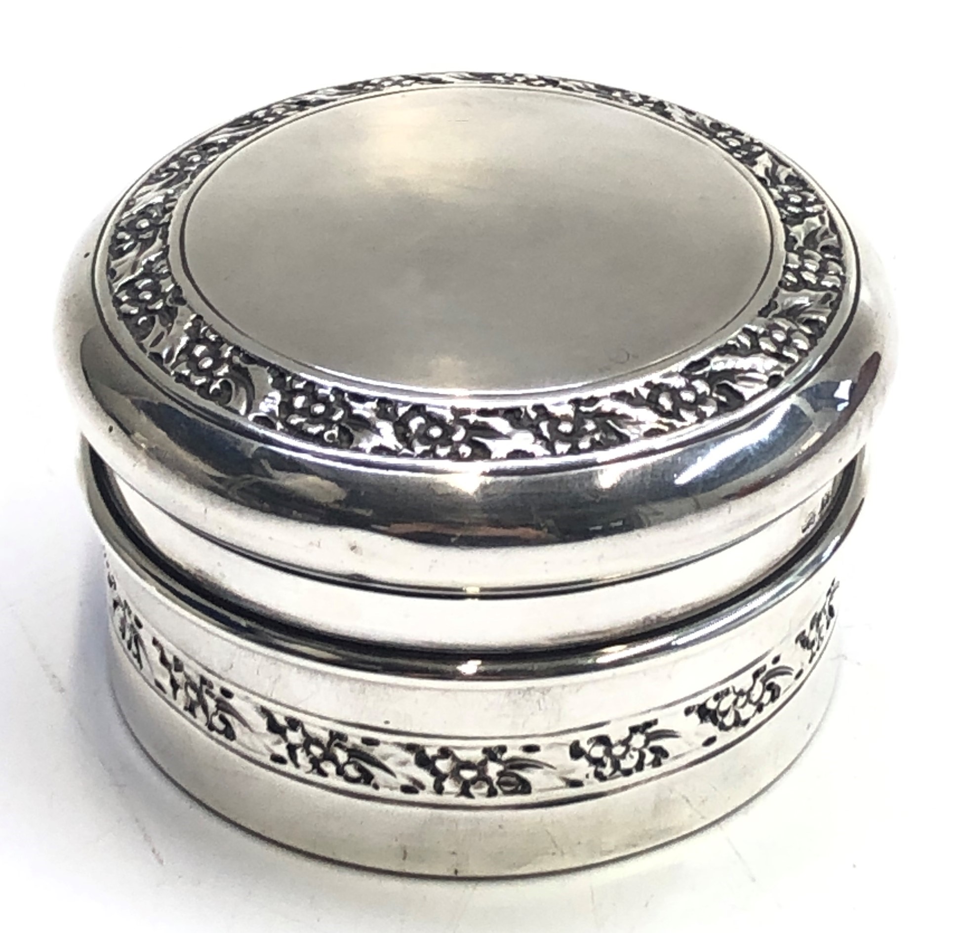 Lot 2088 - A lidded round silver box with two bands of