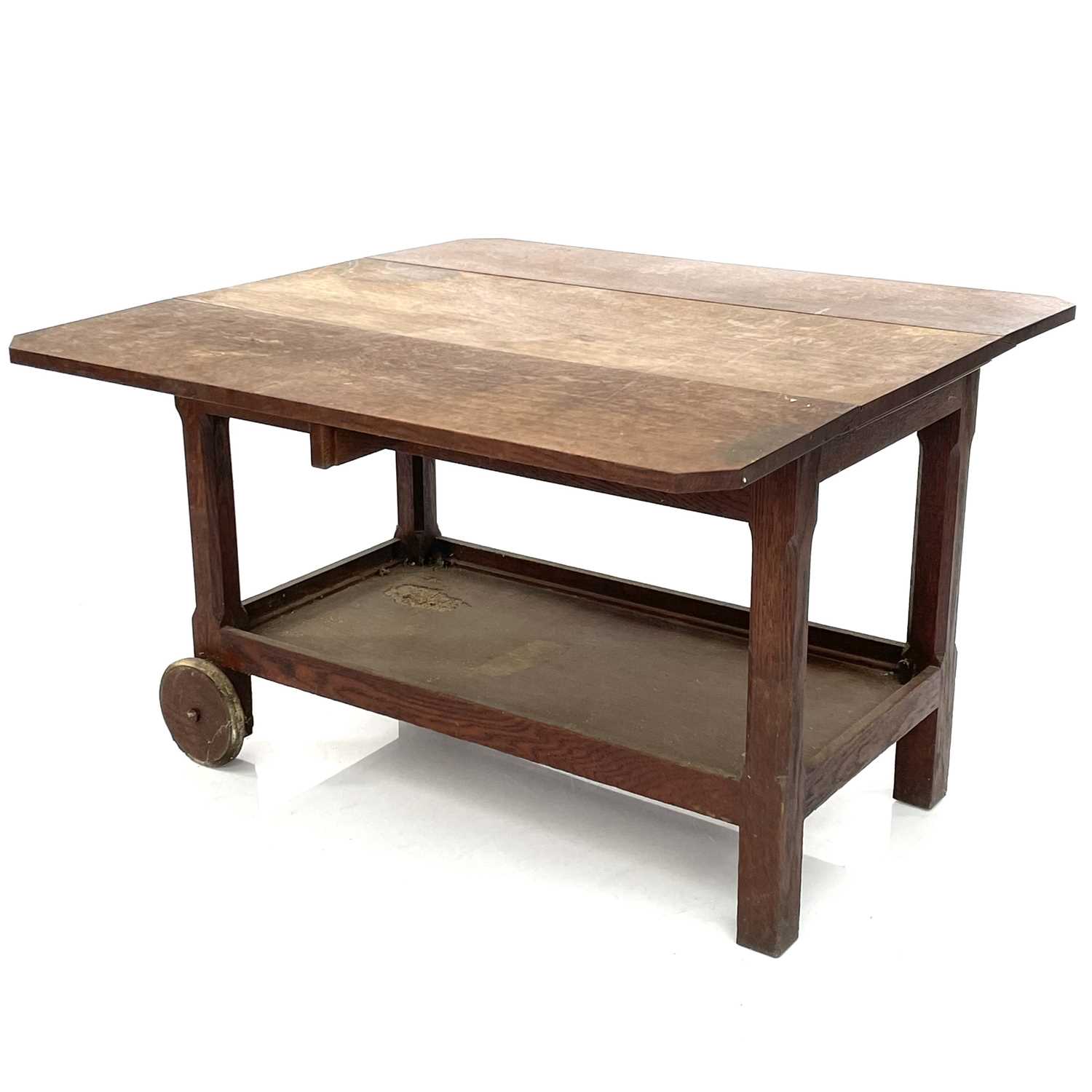 Lot 1918 - An Arts and Crafts oak low trolley, with