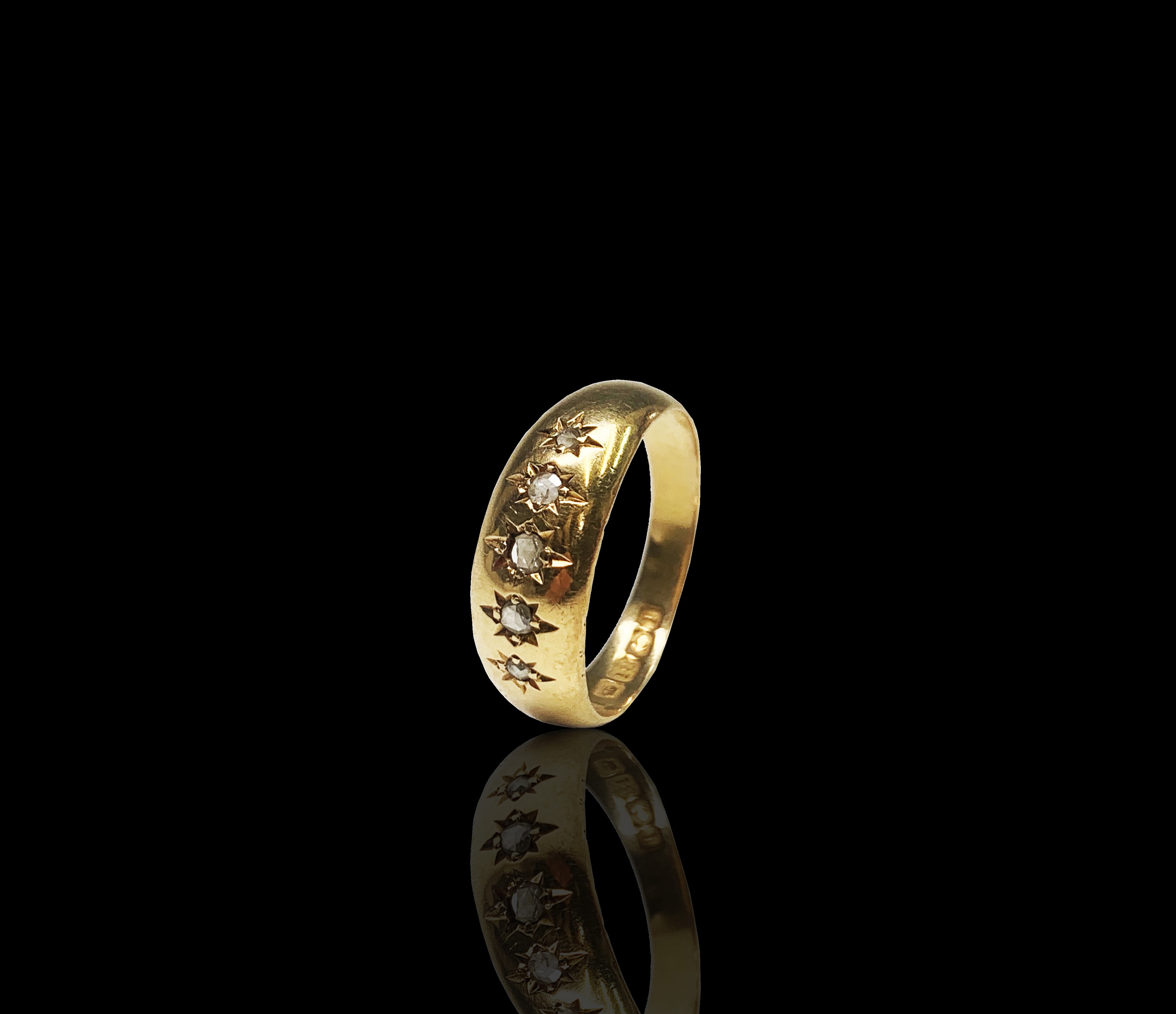 Lot 408 - An 18ct gold ring gipsy set with five