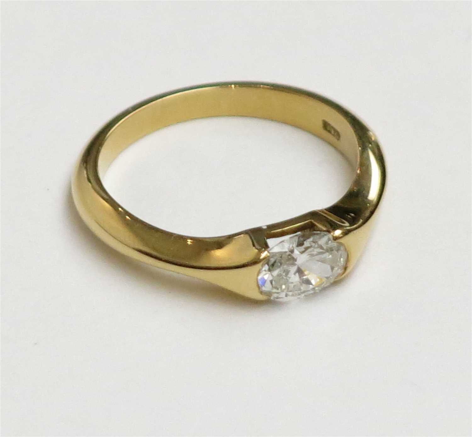 Lot 2411 - An 18ct gold post-war ring set with an oval