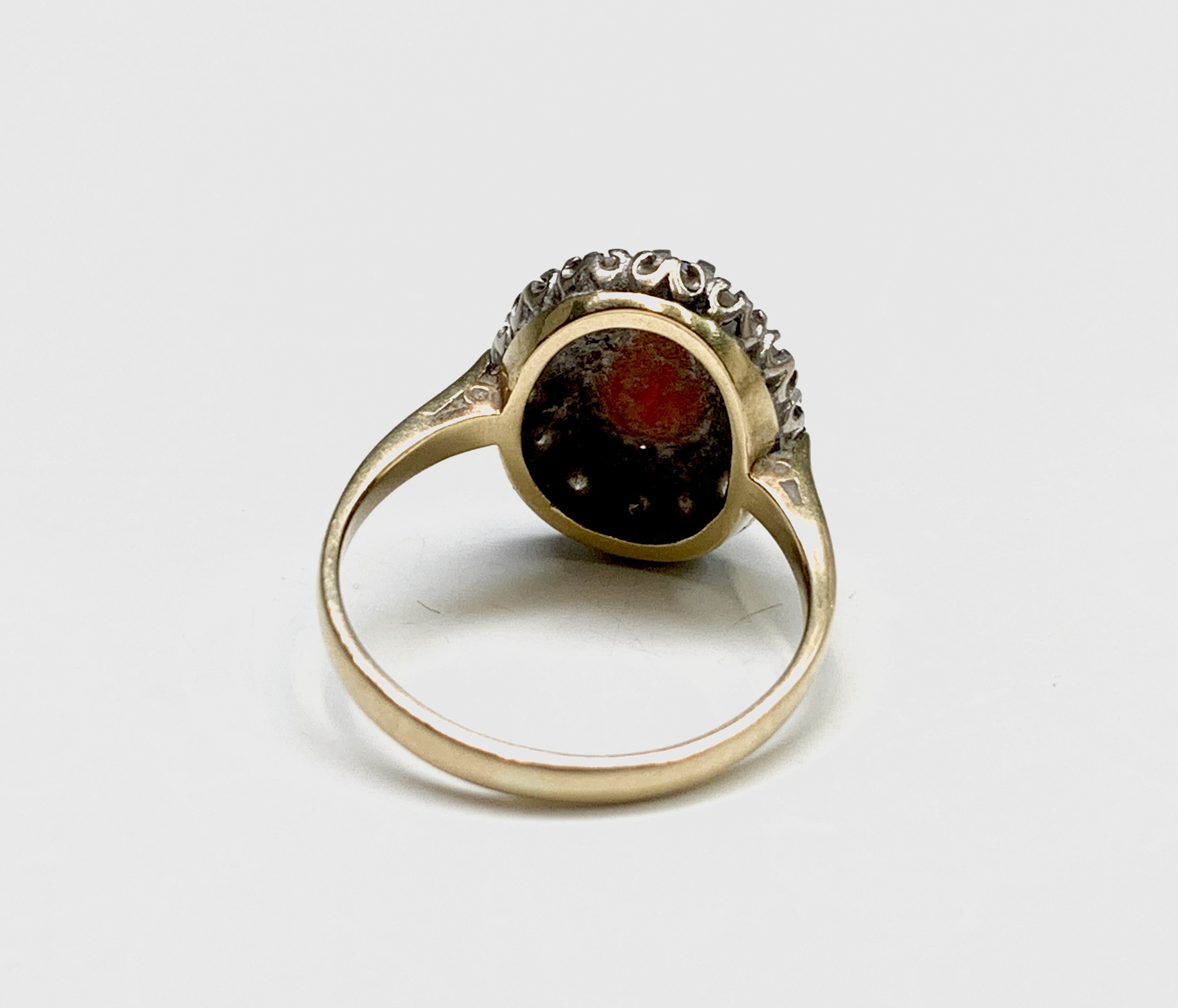 Lot 198 - A gold ring with an oval red stone and
