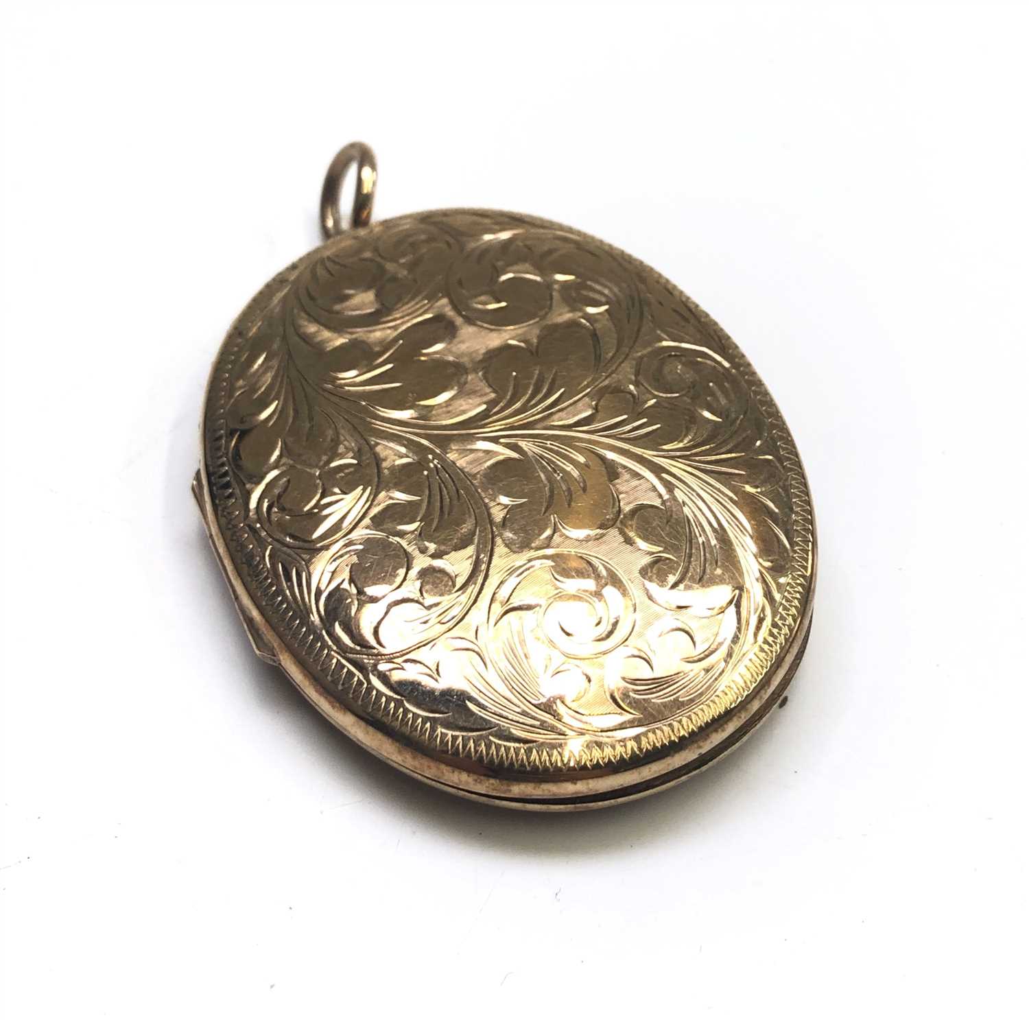 Lot 2592 - A large engraved 9ct gold locket, 23.9g.