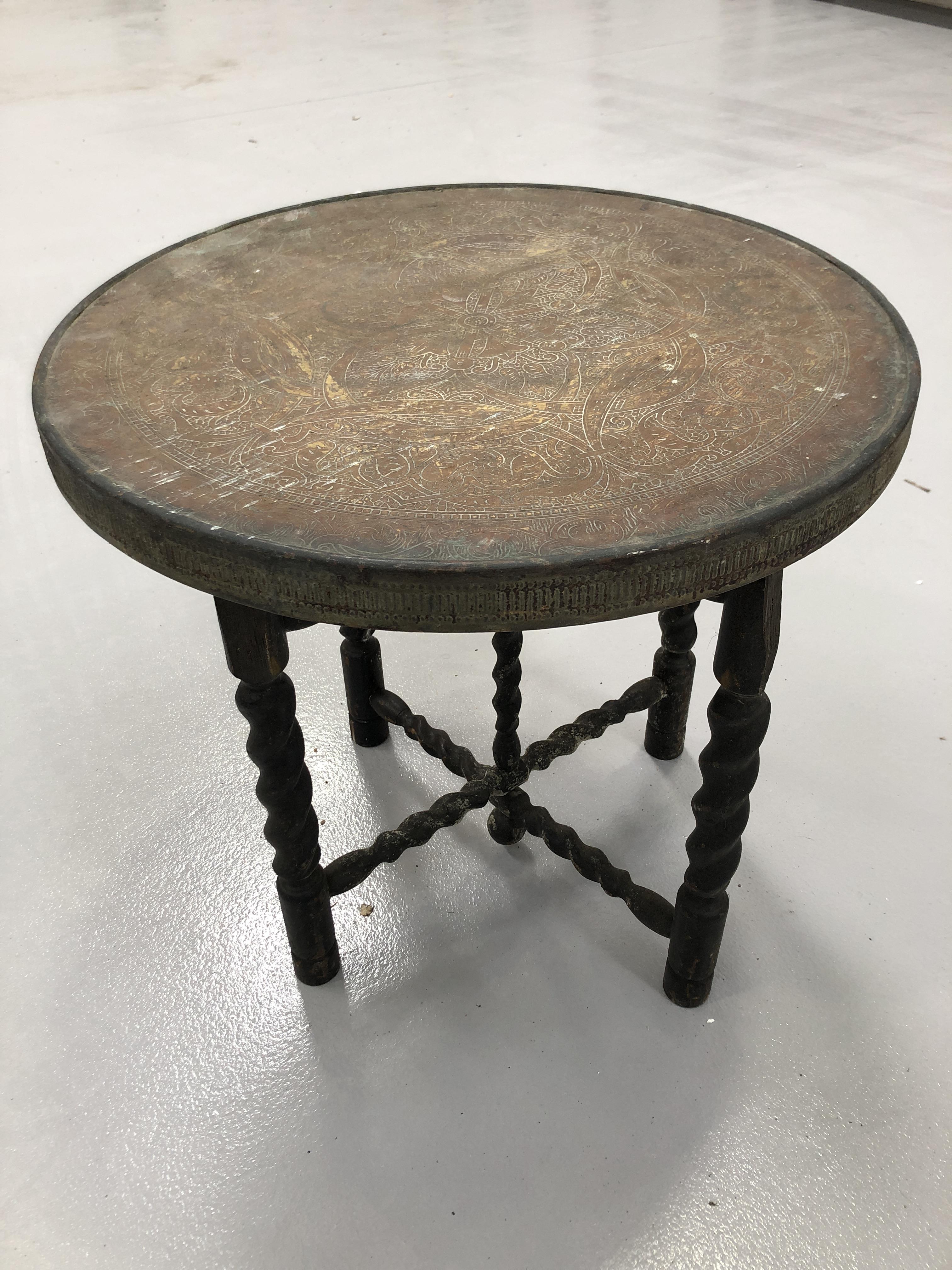 Lot 118 - Brass Benares style table on folding base,