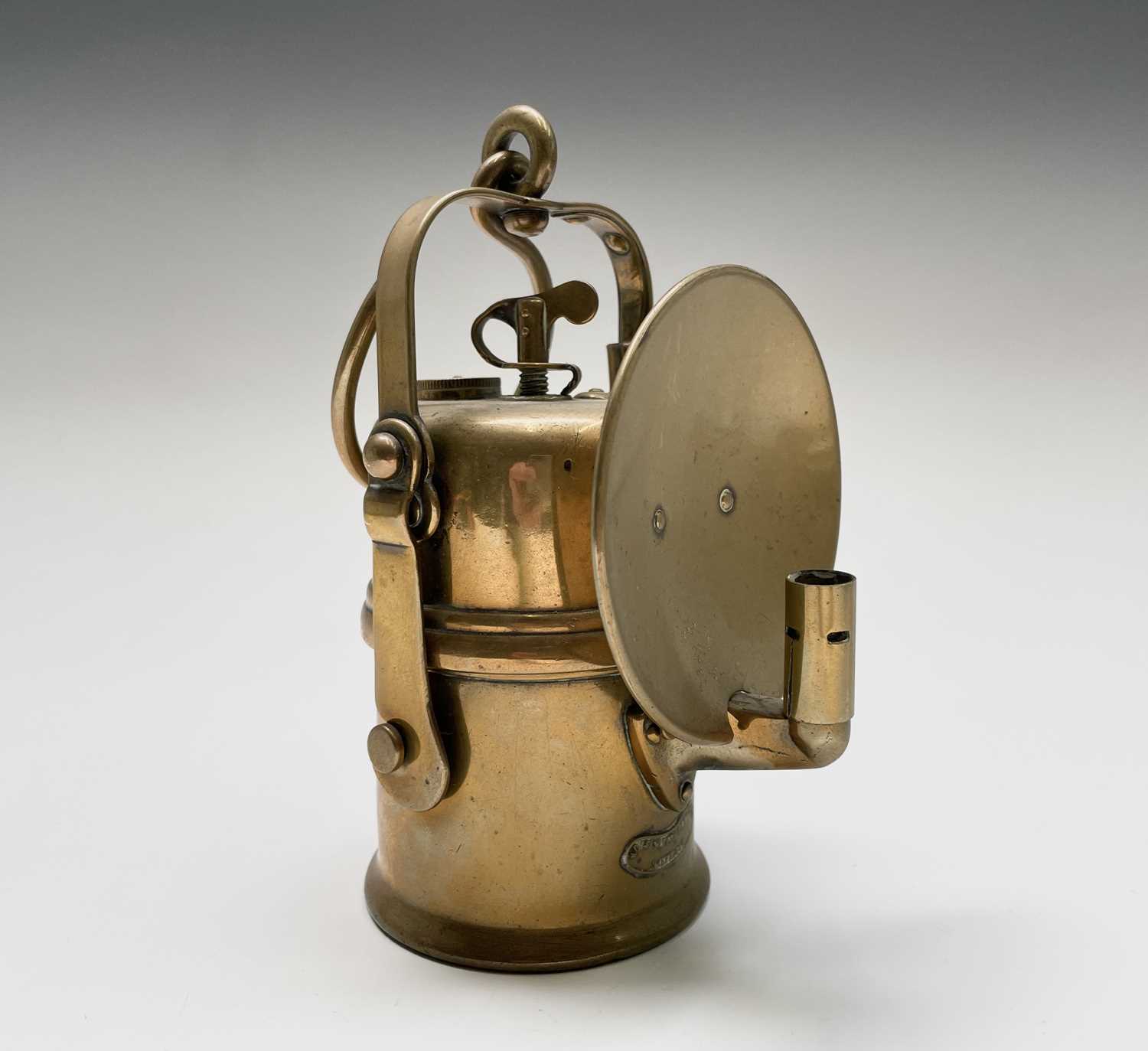 Lot 250 - A brass miner's safety acetylene lamp, by