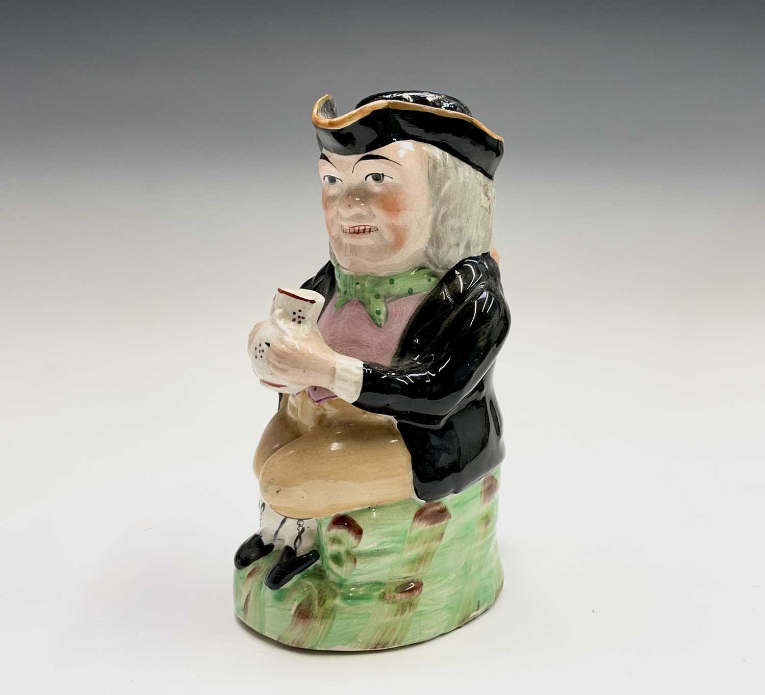 Lot 343 - A Staffordshire pottery Toby jug, circa 1820,