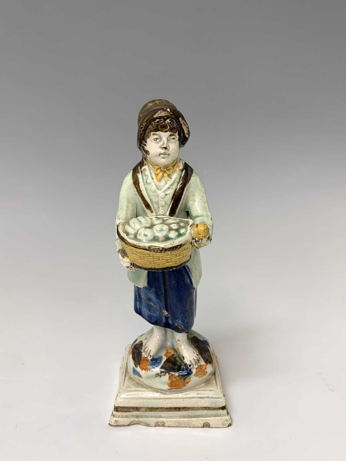 Lot 476 - A Prattware figure of a boy, late 18th