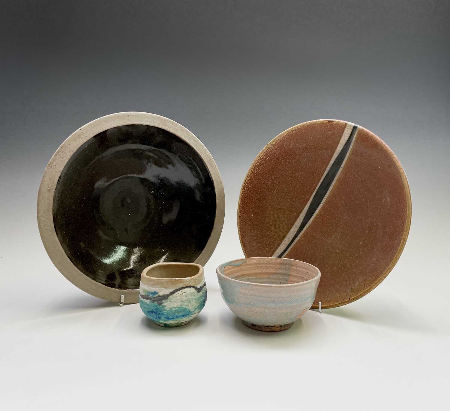 Lot 830 - A studio pottery plate with central unglazed