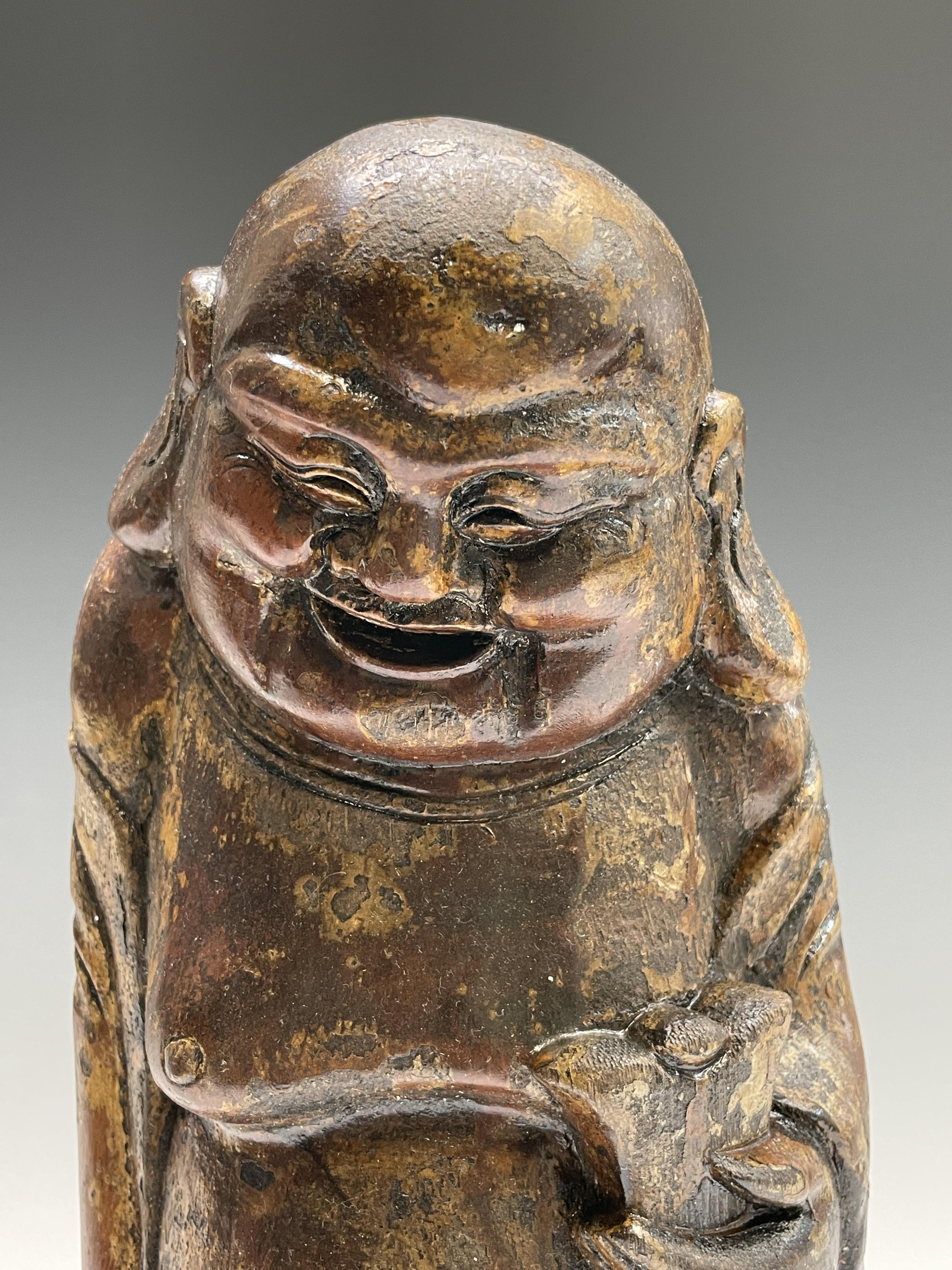 Lot 381 - A Chinese carved bamboo figure of Buddha,