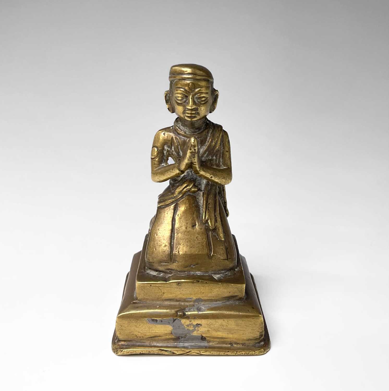 Lot 1050 - An Indian brass figure of a priest,