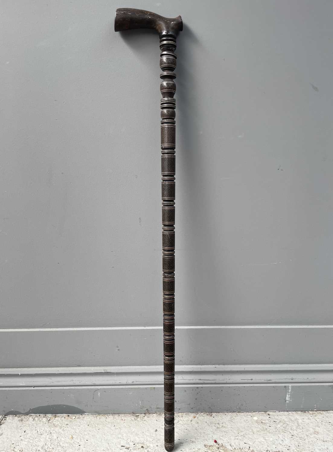 Lot 1061 - A Persian wooden sectional walking stick,