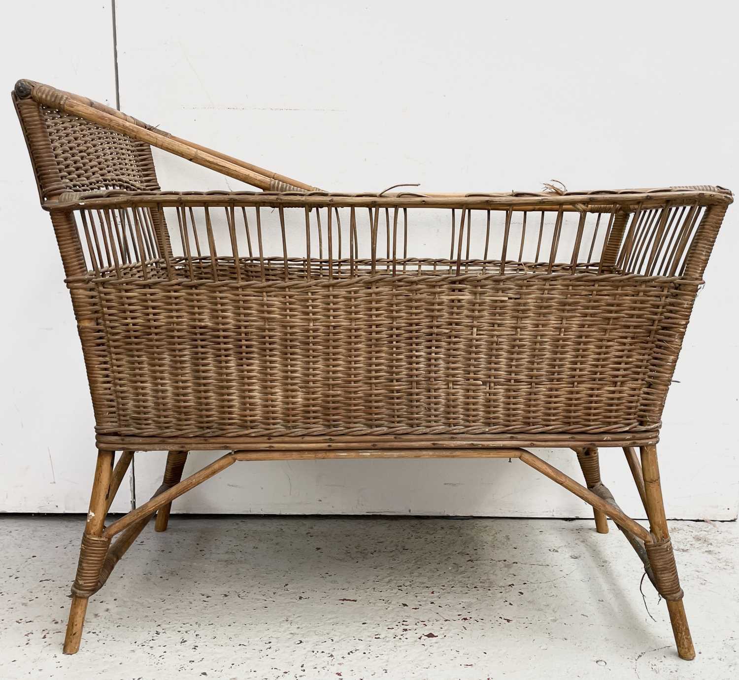 Lot 172 - A wicker cot, early 20th century, width 94cm.