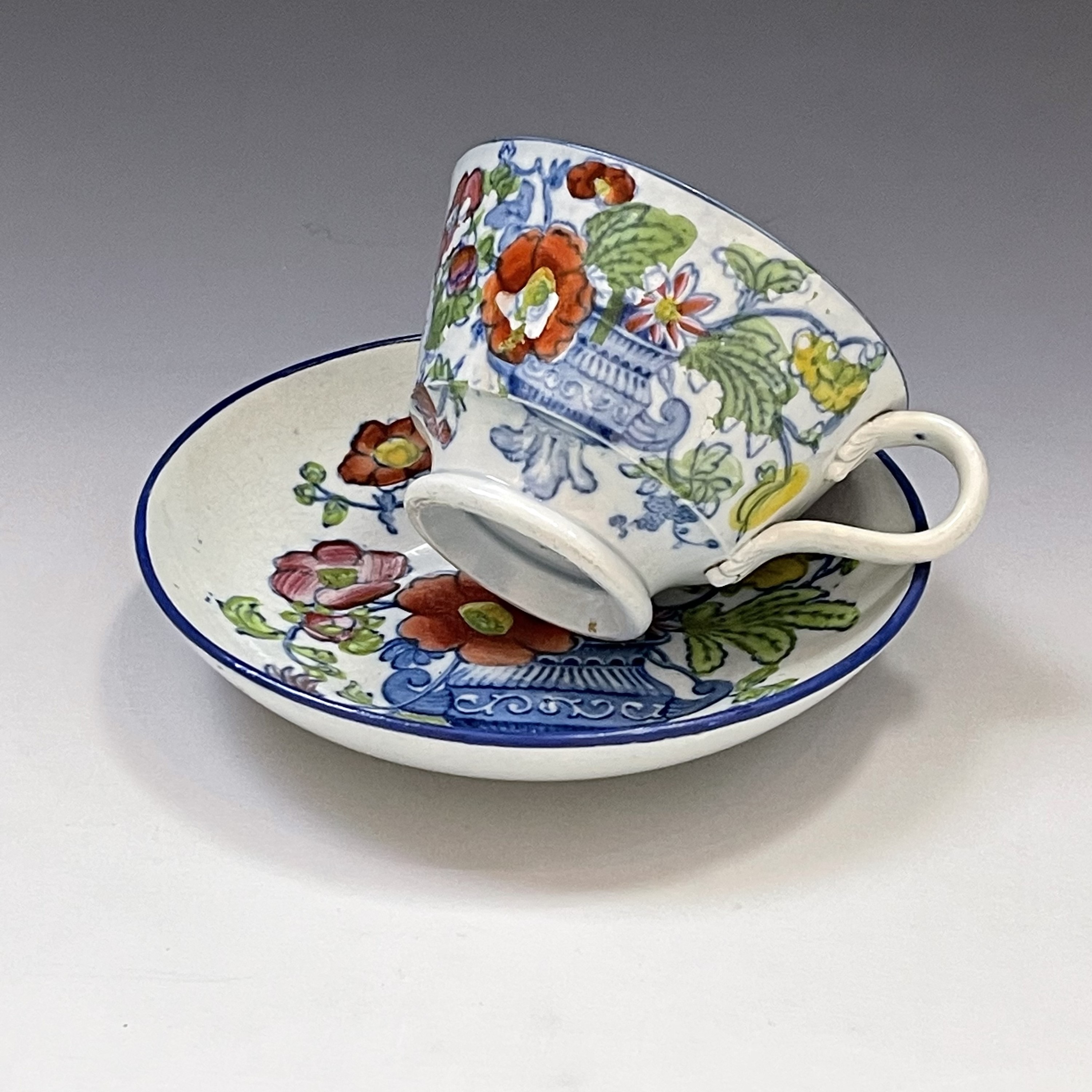 Lot 835 - A Cambrian pottery cup and saucer, over