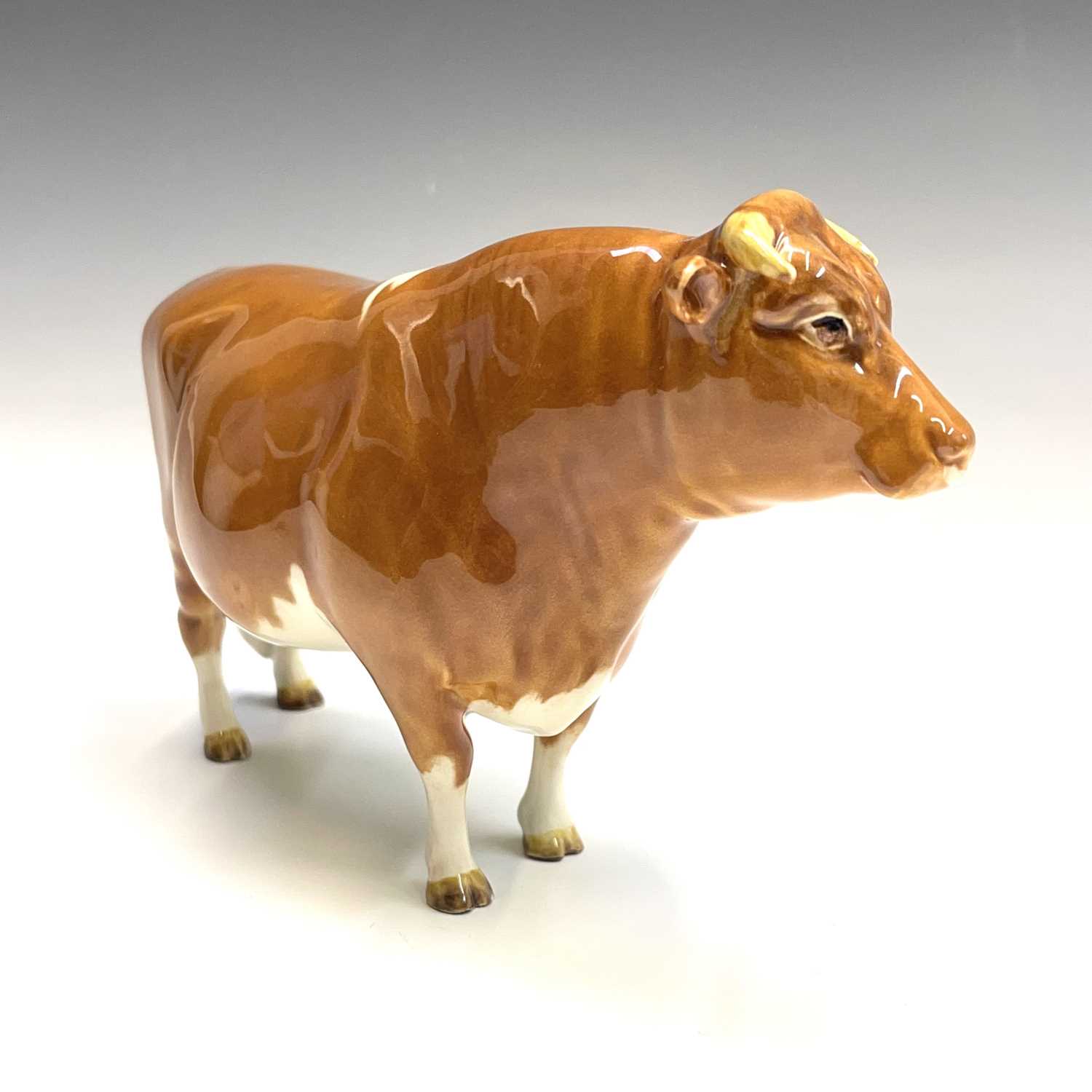 Lot 840 - Three Beswick models of Guernsey cattle,