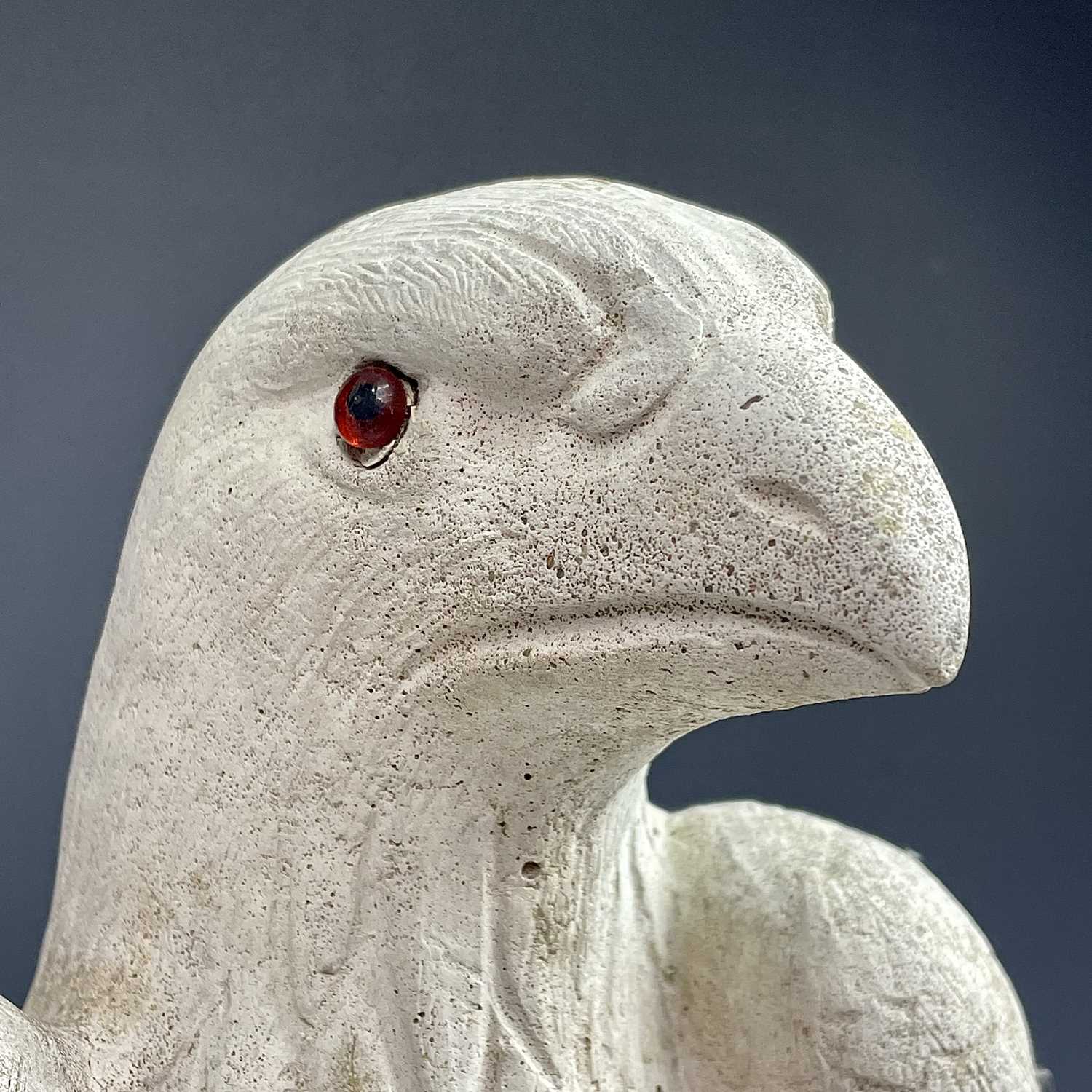 Lot 605 - A pair of reconstituted stone birds of prey,