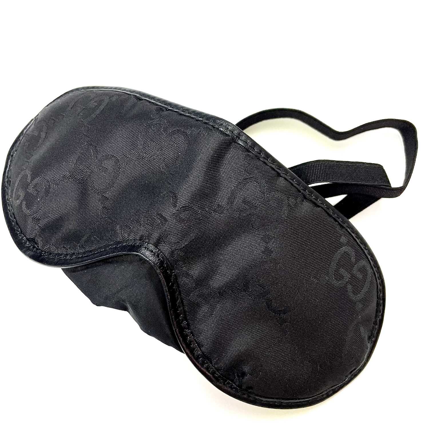 Lot 1012 - A Gucci eye mask within bag.