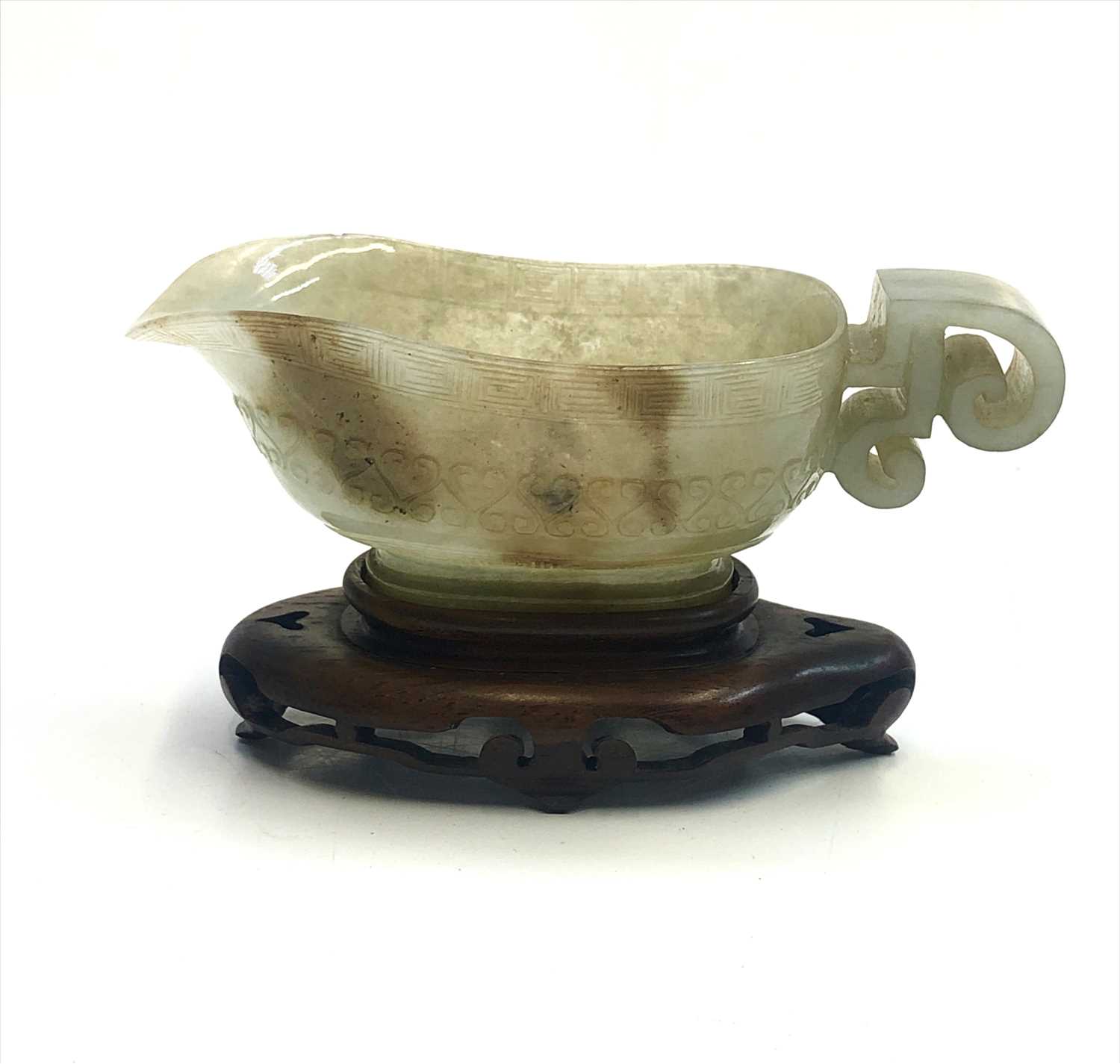 Lot 21 - A Chinese carved jade libation cup, possibly